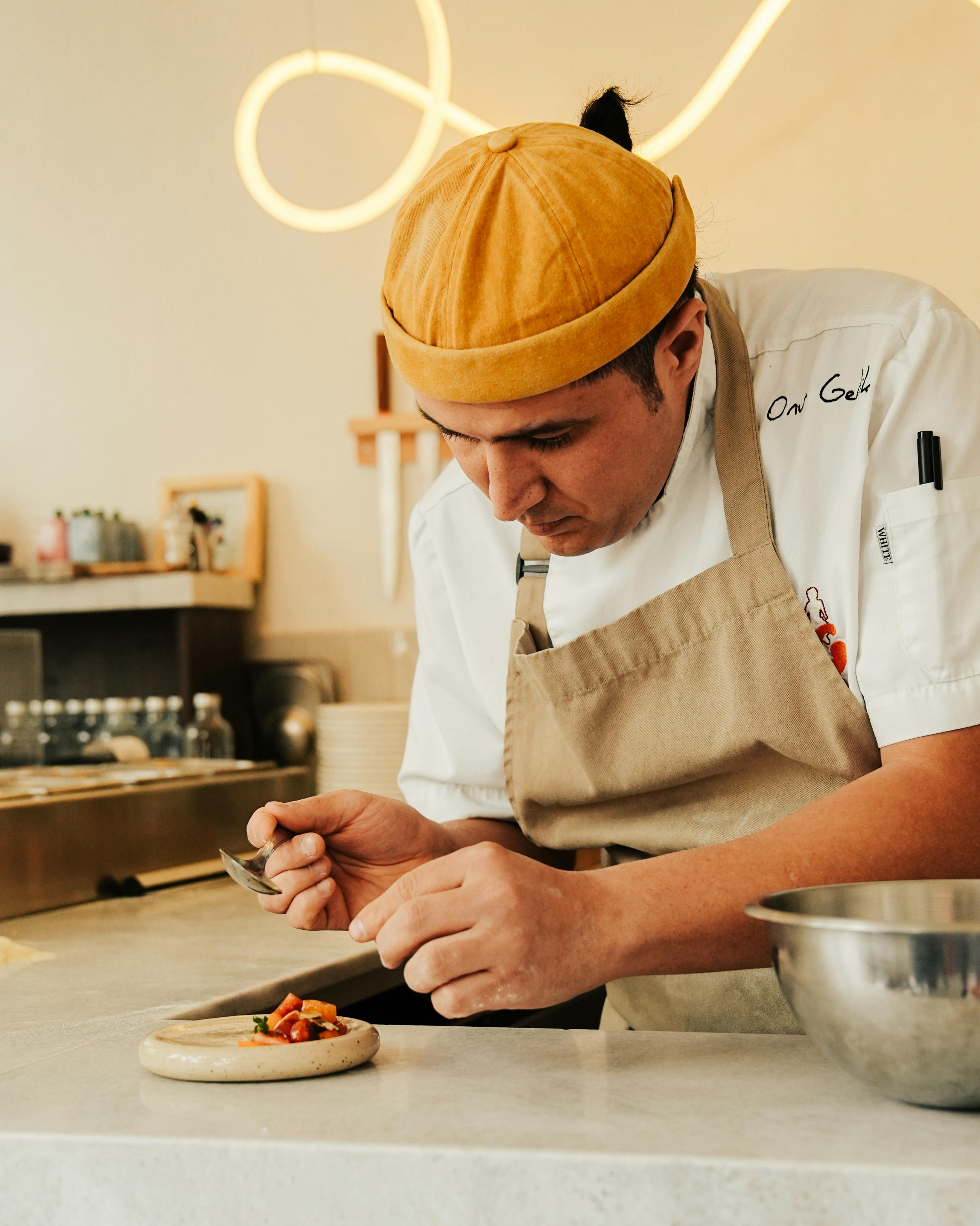 Chef Precisely Plating a Dish in Modern Kitchen · Free Stock Photo