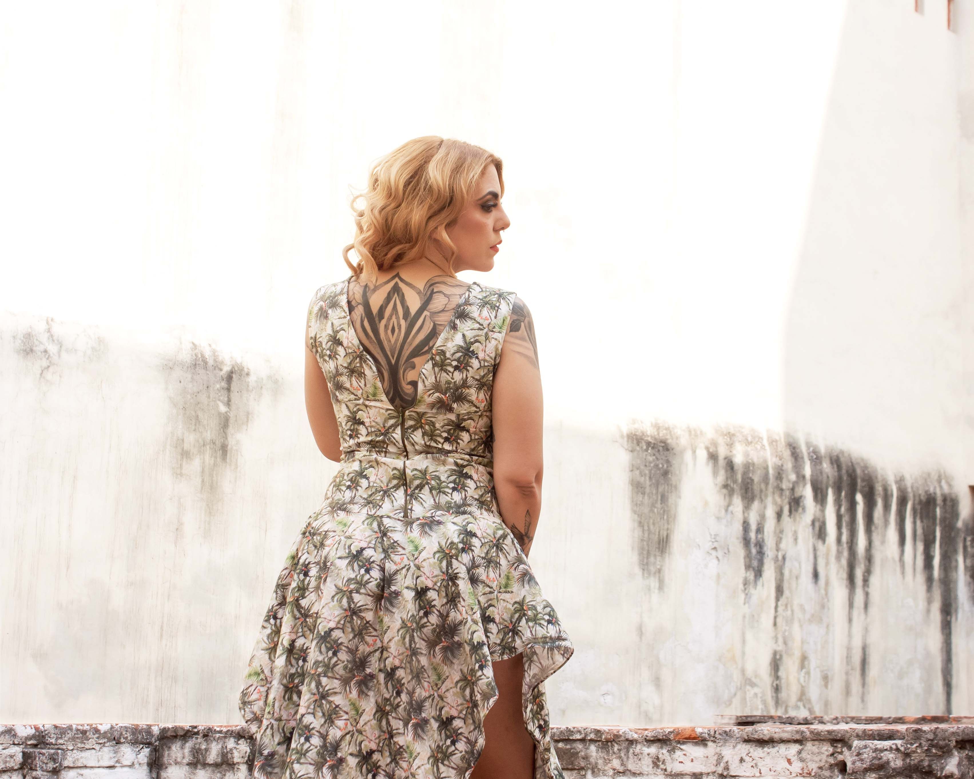 Elegant Woman in Floral Dress with Back Tattoo · Free Stock Photo