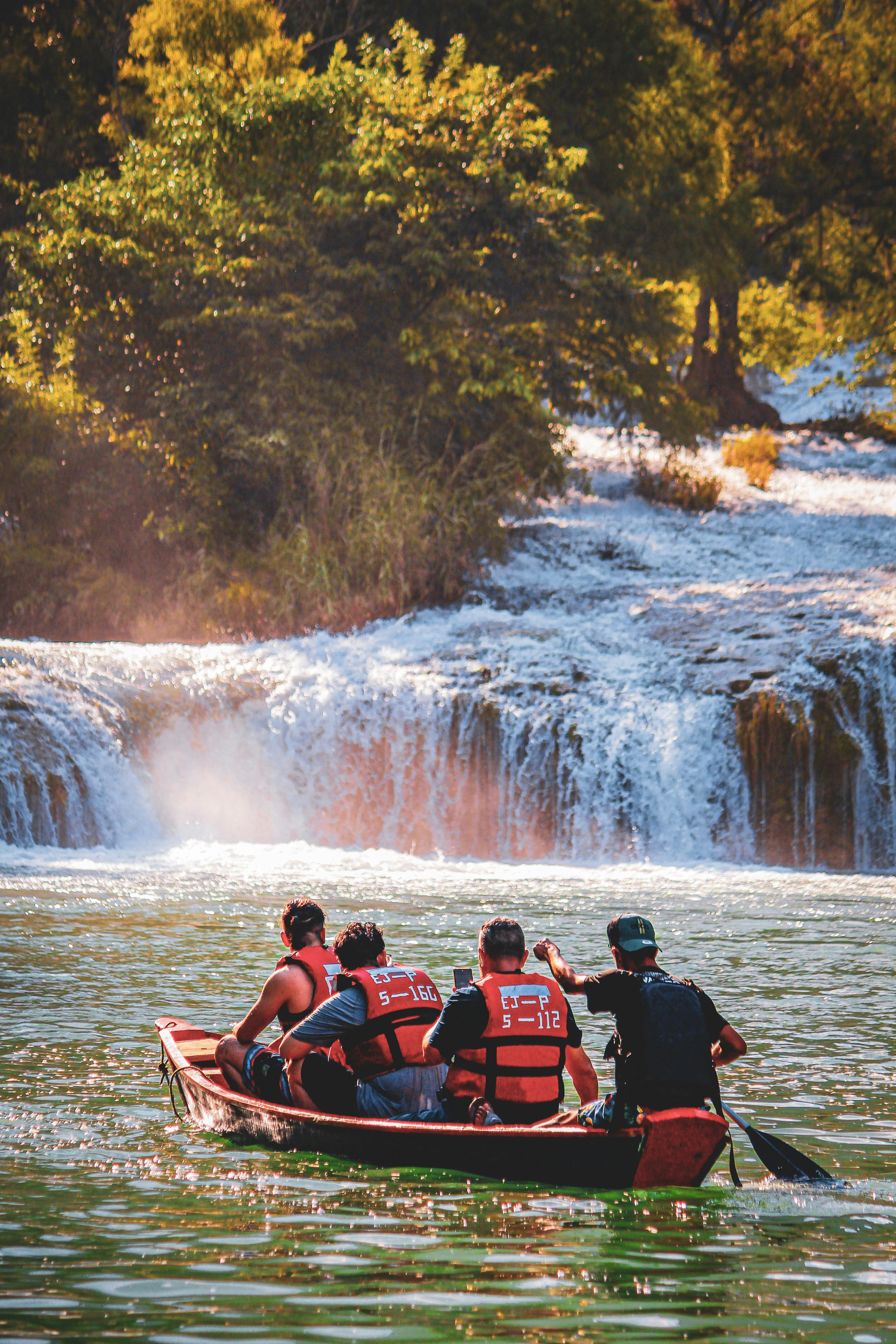 Canoeing Adventure Near Scenic Waterfall · Free Stock Photo