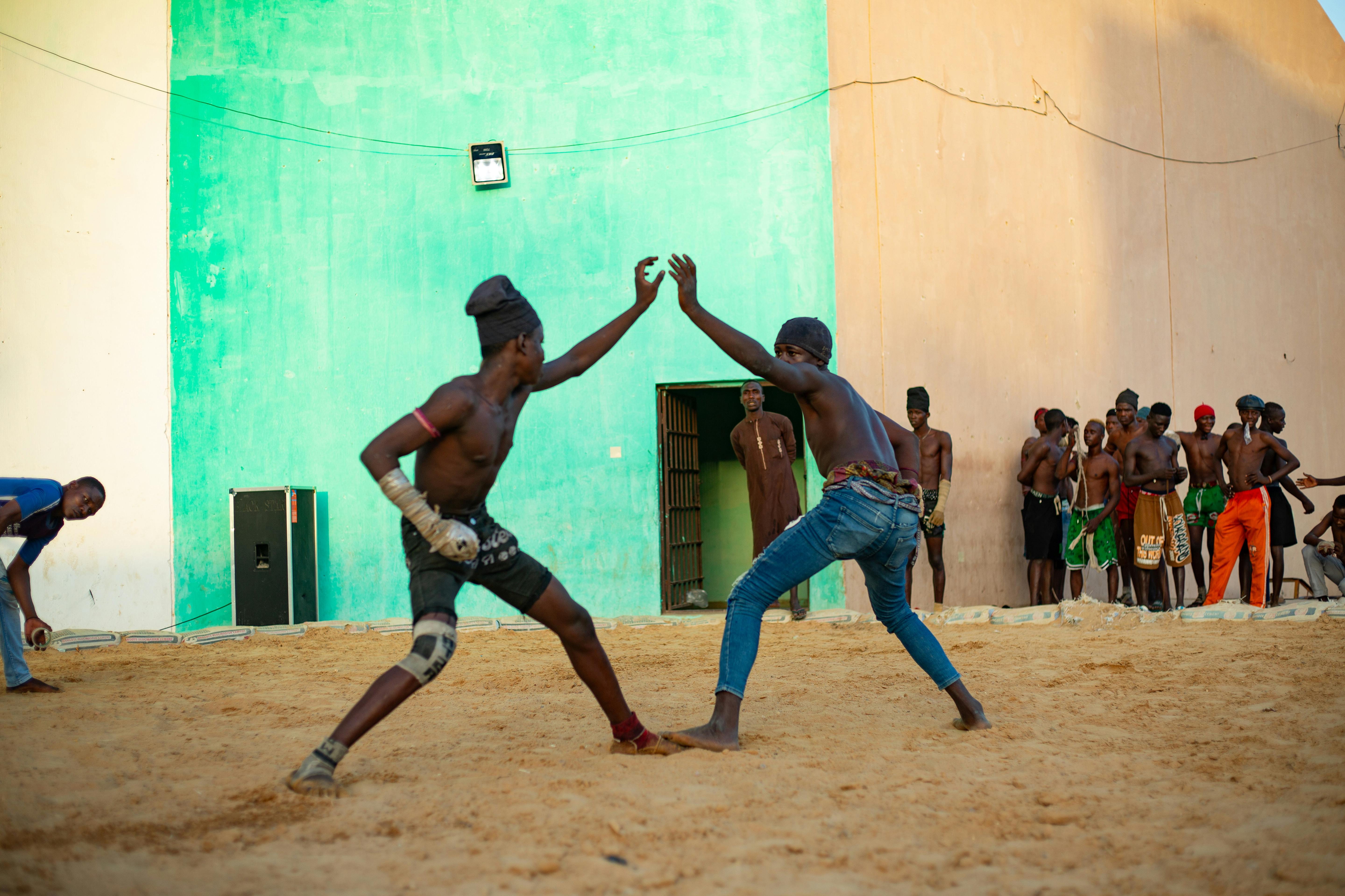 Traditional Wrestling Match in Sandy Arena · Free Stock Photo