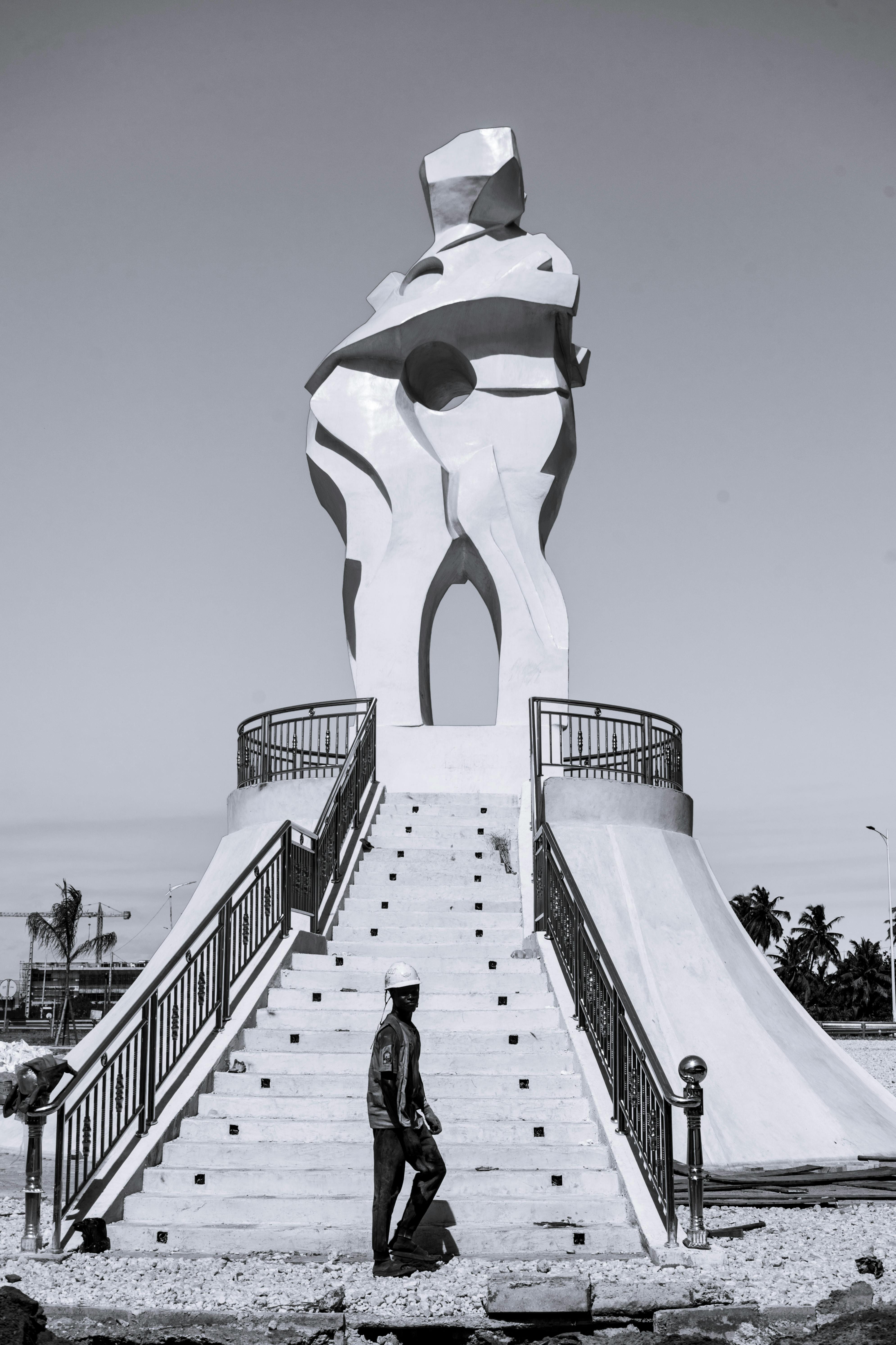 Monochrome Urban Statue with Visitor · Free Stock Photo