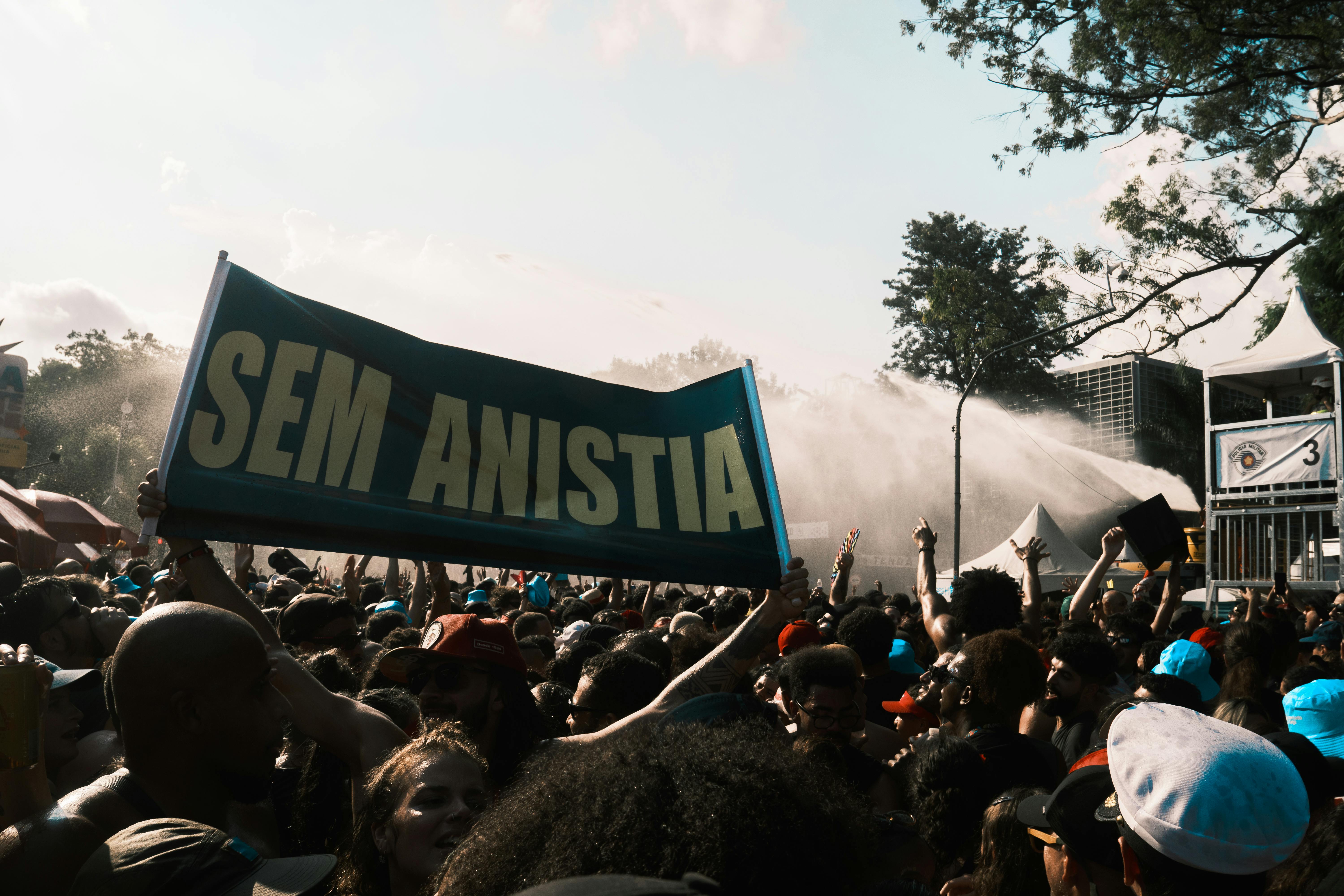 Crowd Holding 'Sem Anistia' Banner During Protest · Free Stock Photo