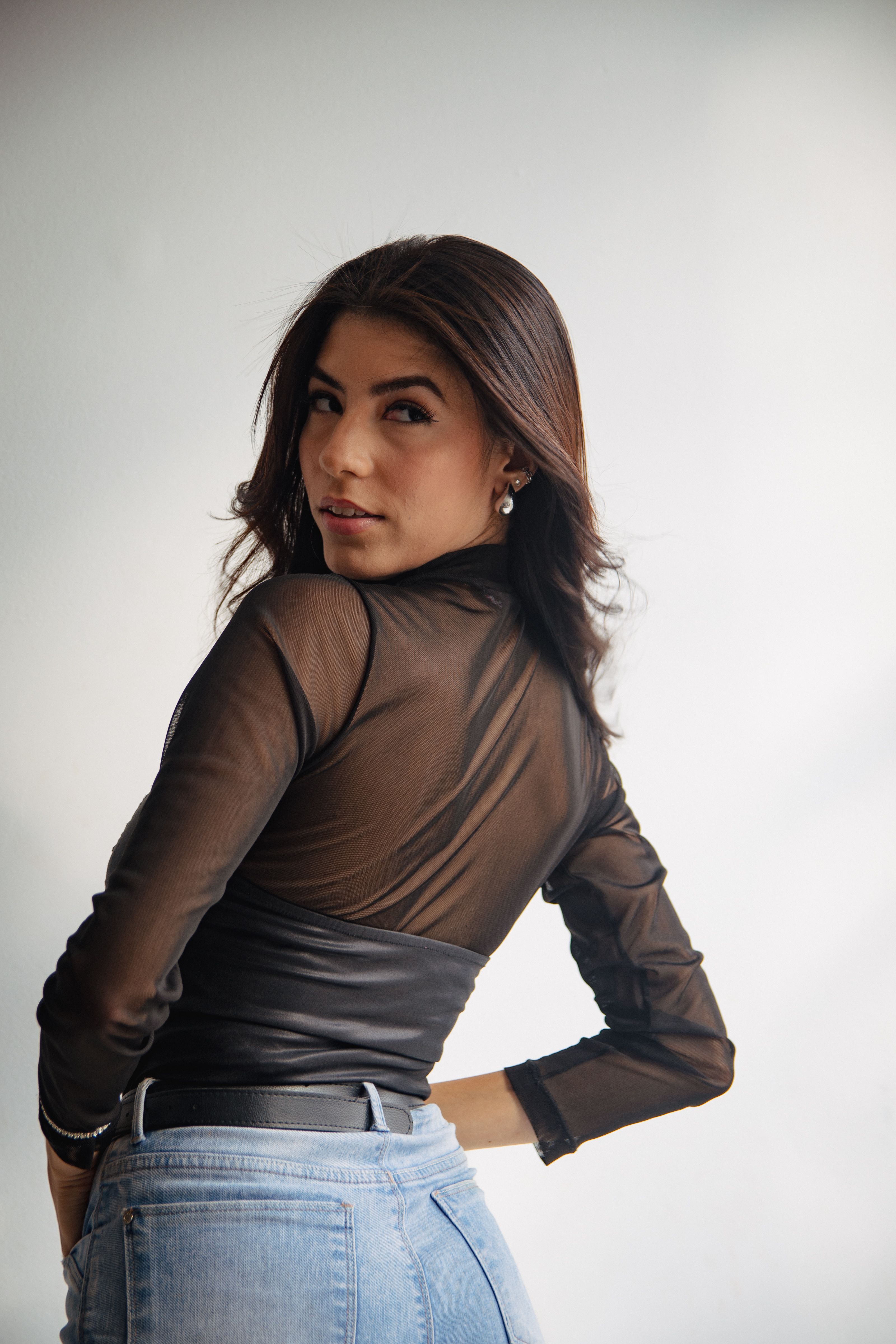 Elegant Woman Posing in Stylish Sheer Top · Free Stock Photo