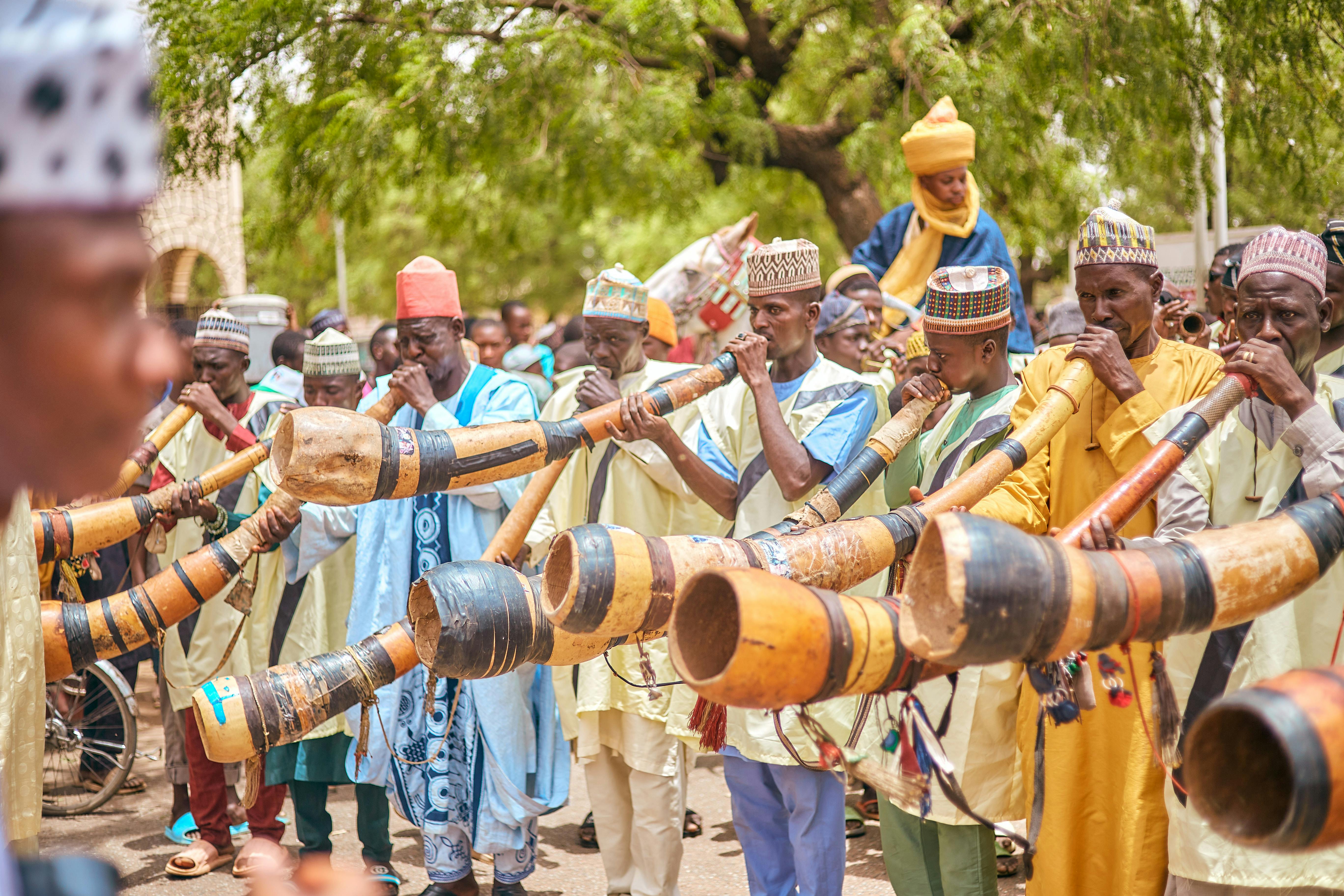Traditional Horn Players in Colorful Attire Outdoor · Free Stock Photo