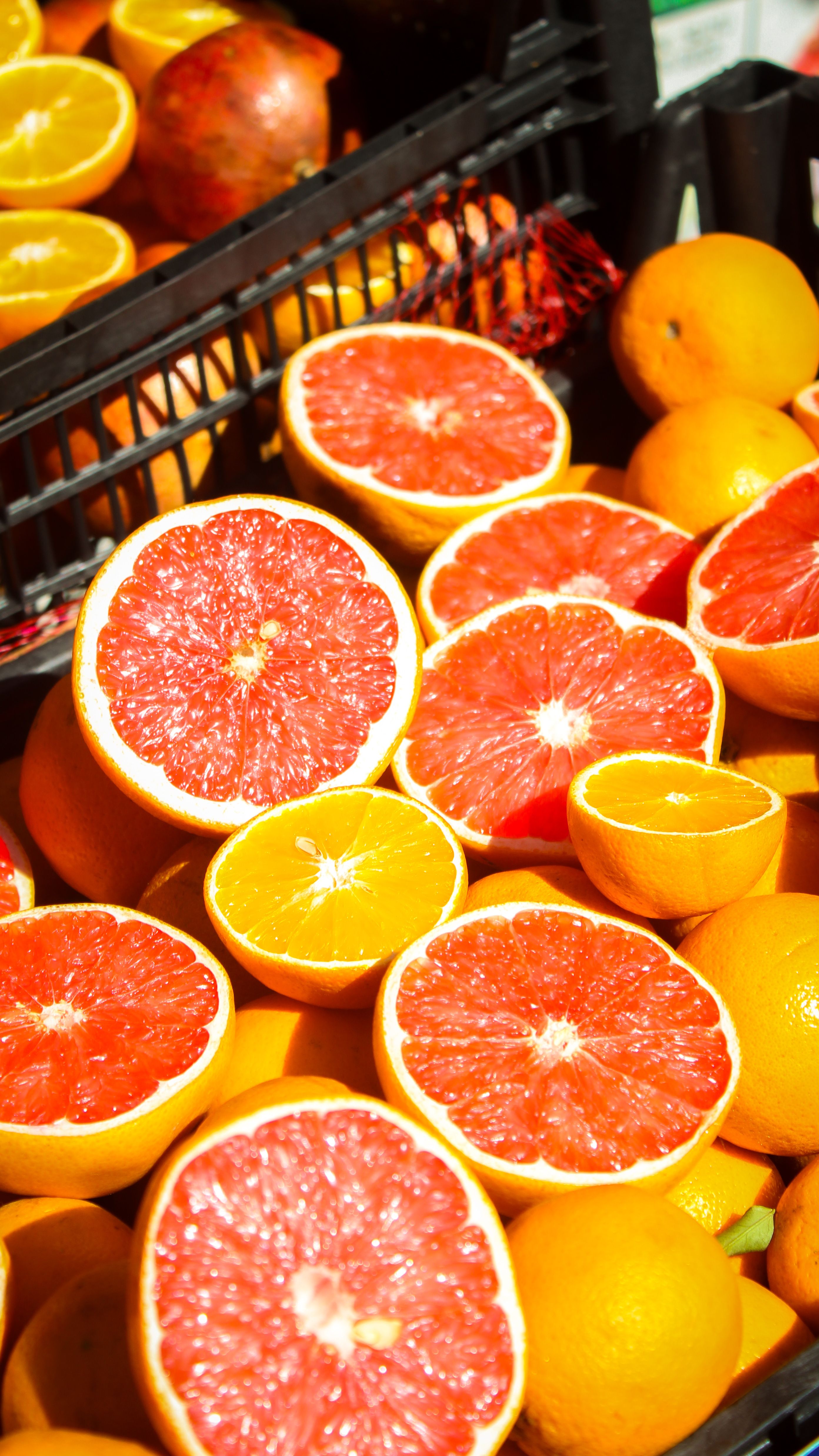 Vibrant Display of Cut Citrus Fruits at Market · Free Stock Photo