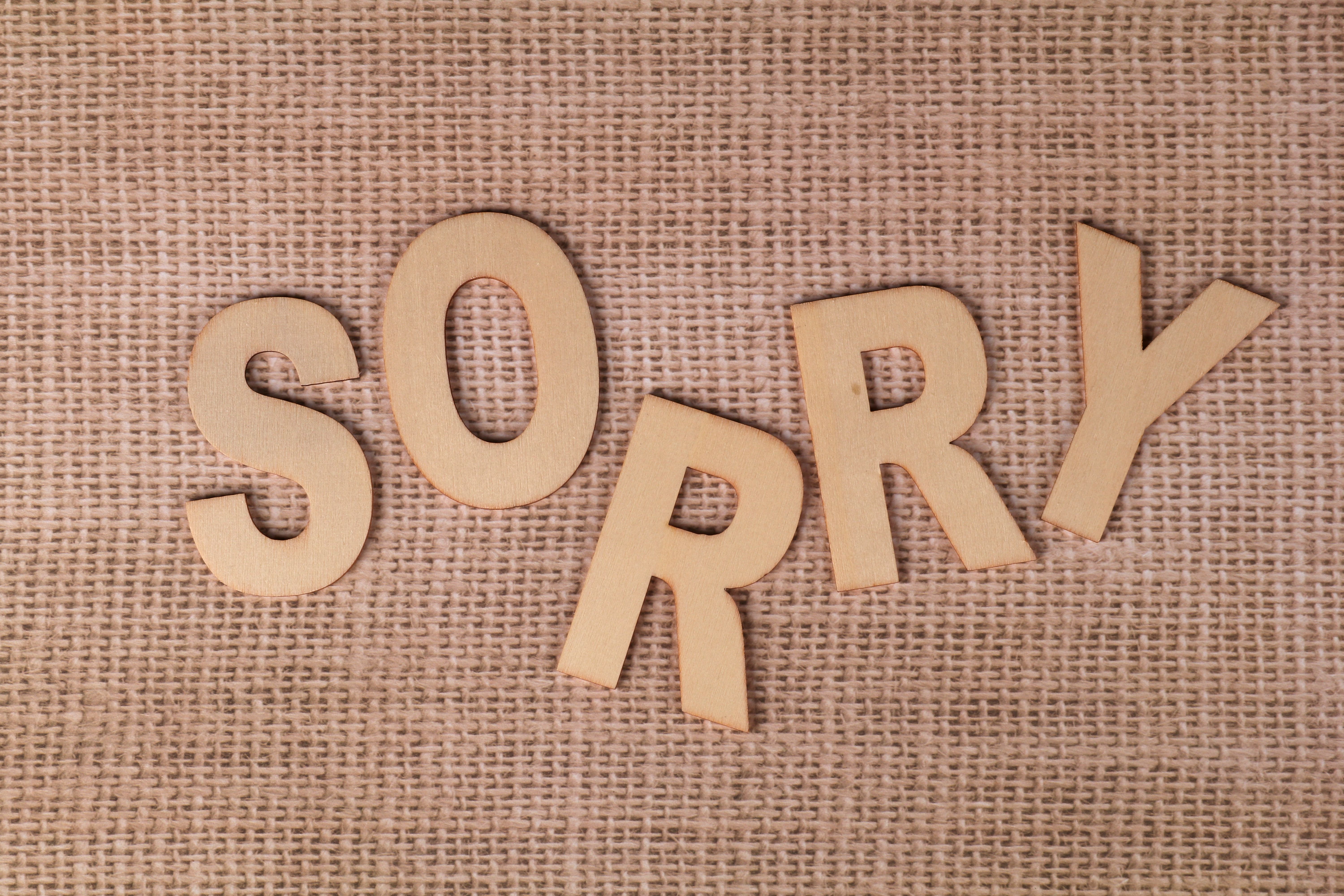 Wooden Letters Spell Sorry on Burlap Background · Free Stock Photo