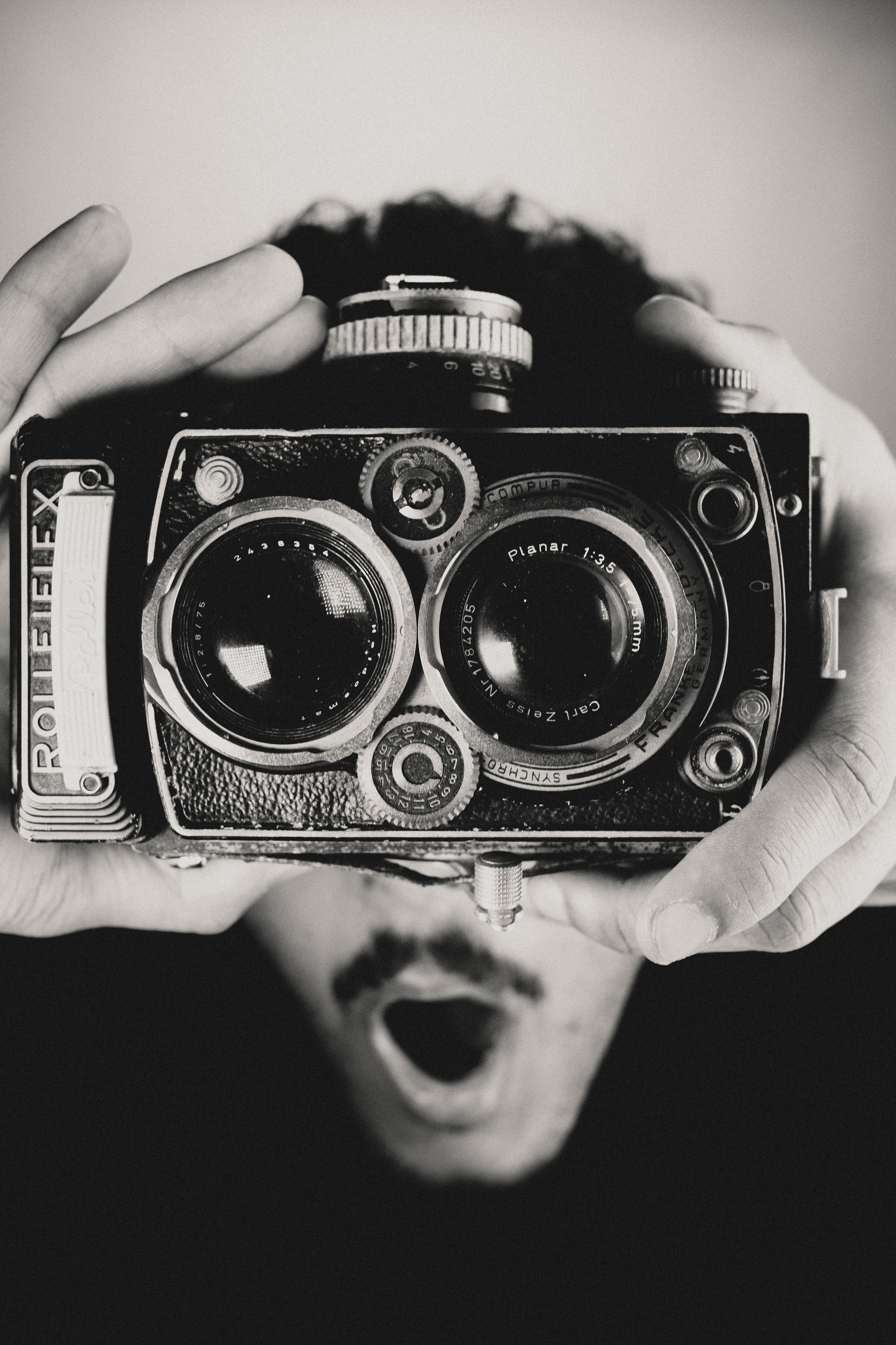 Vintage Camera Capturing Photographer's Expression · Free Stock Photo