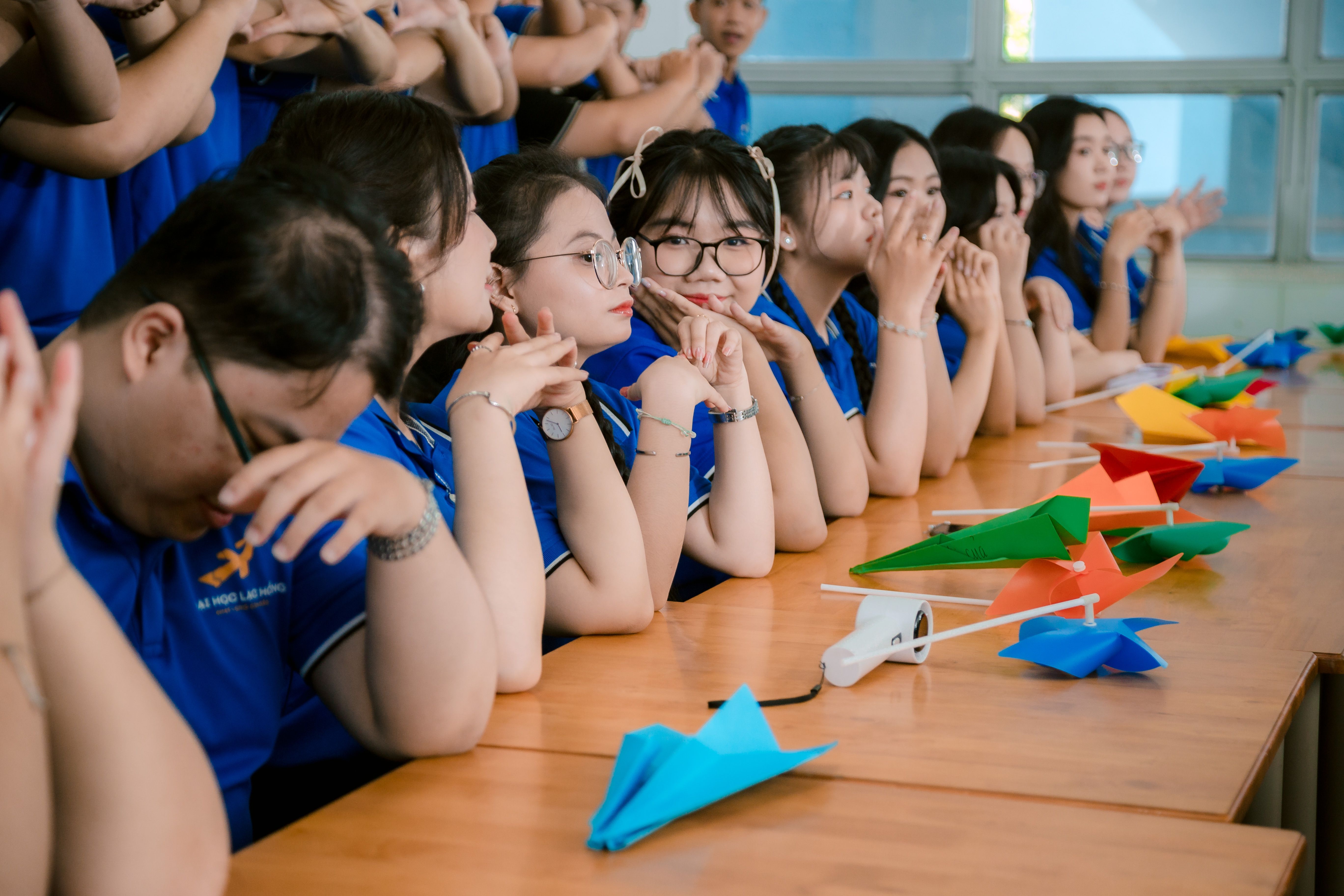 Students Ready with Colorful Paper Planes Indoors · Free Stock Photo