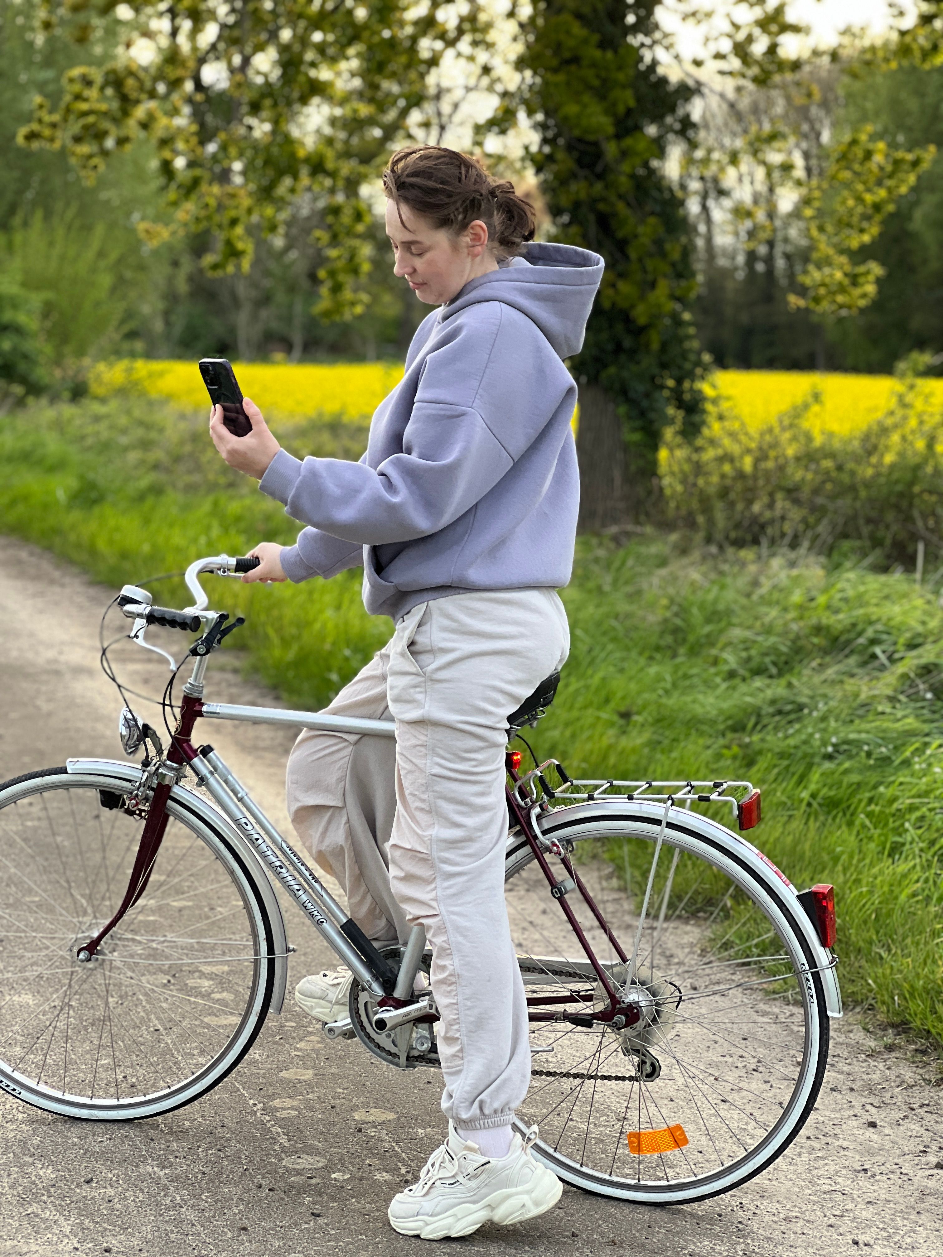 Young Adult Enjoying Spring Bike Ride Outdoors · Free Stock Photo