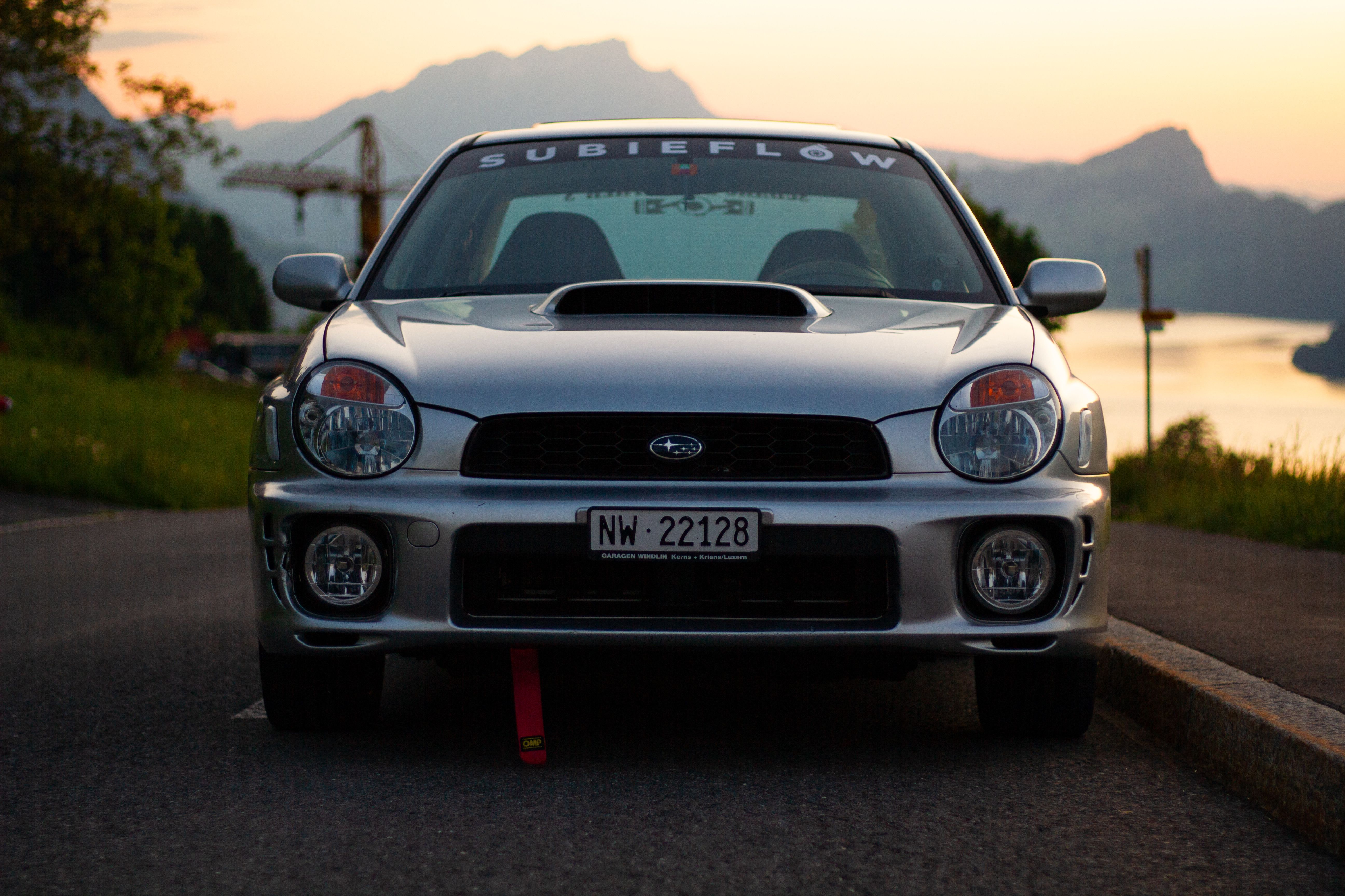 Silver Subaru Car on Scenic Road at Sunset · Free Stock Photo