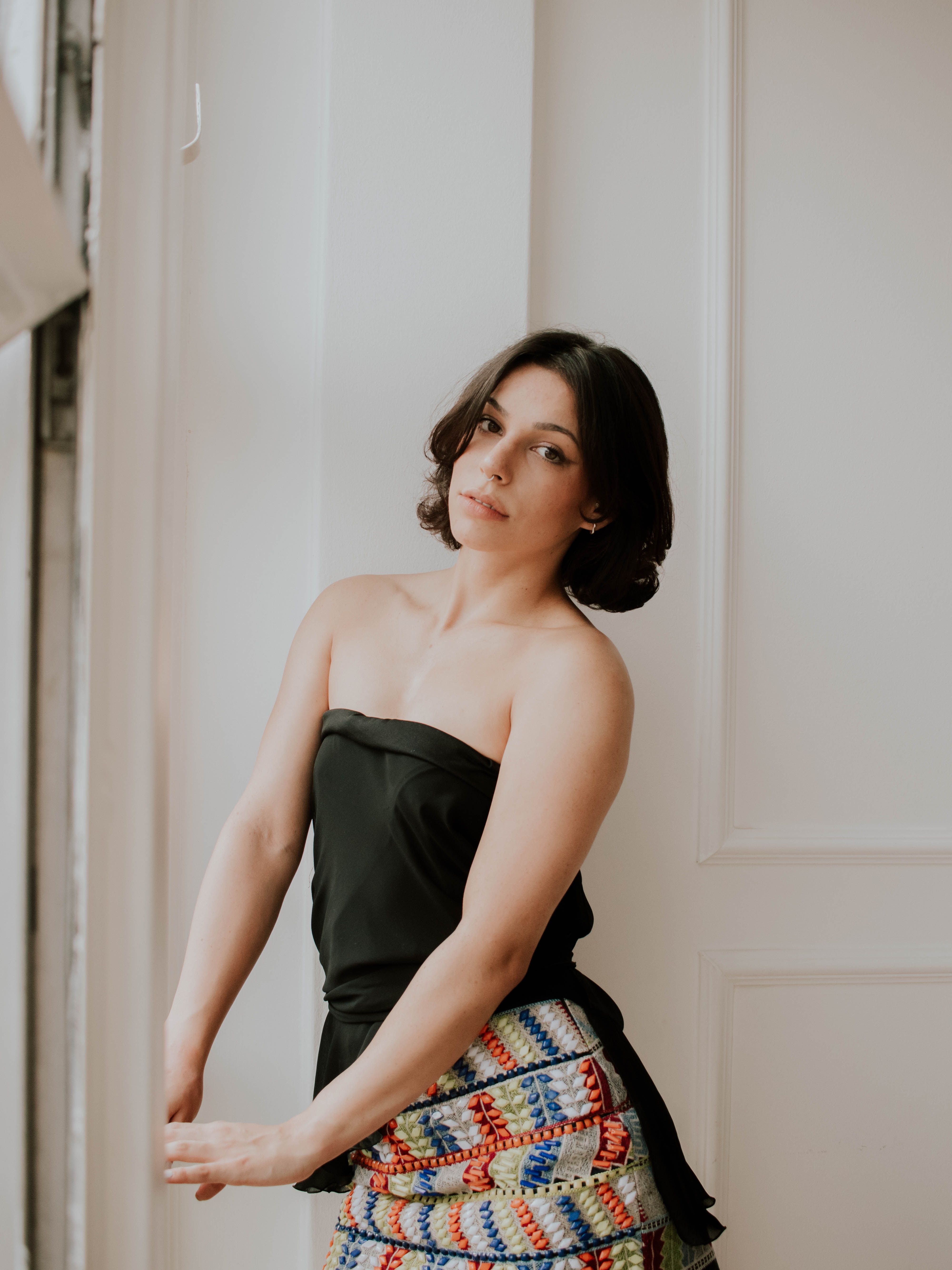 Elegant Woman Posing Indoors in Chic Outfit · Free Stock Photo