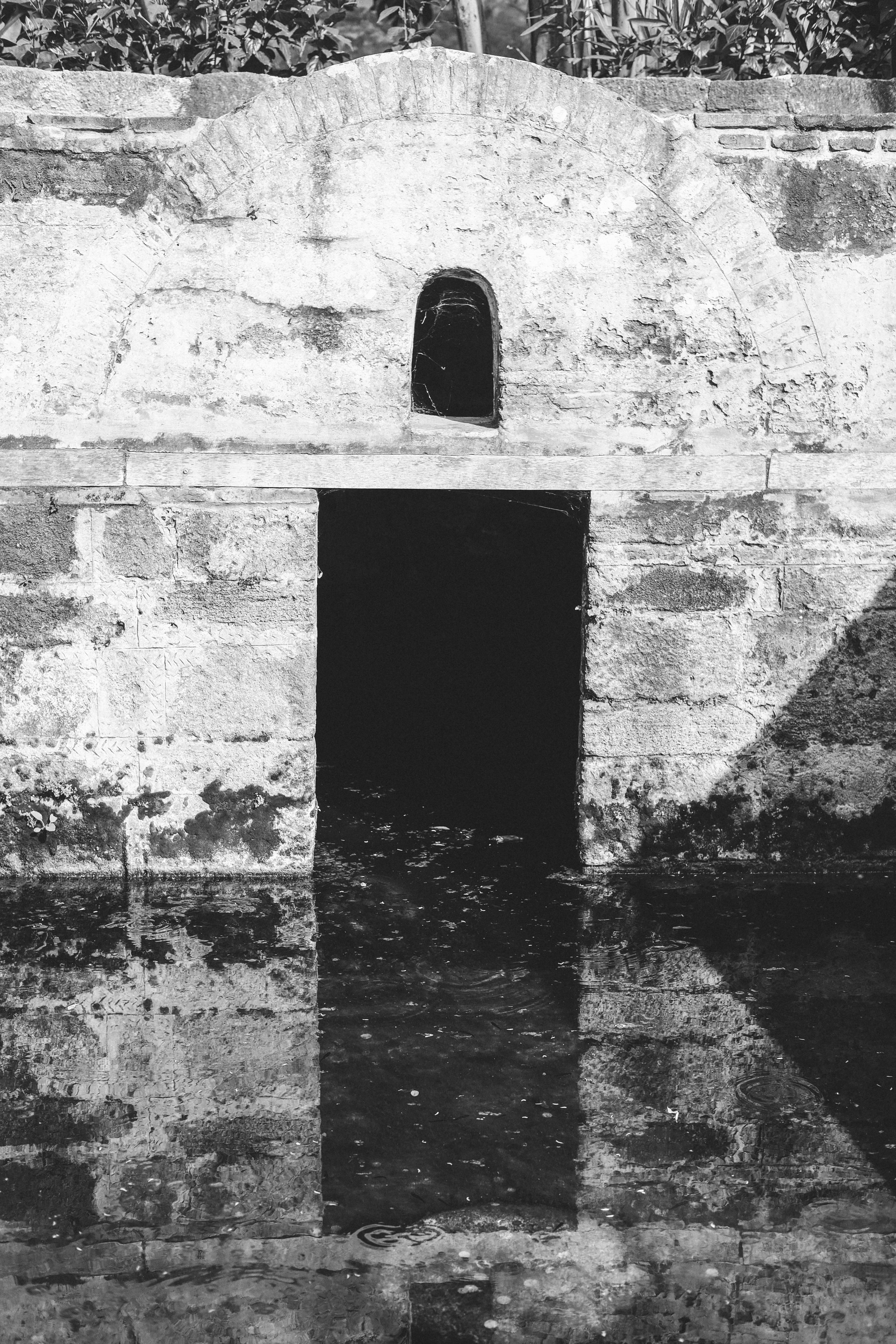 Historic Stone Structure with Water Reflection · Free Stock Photo
