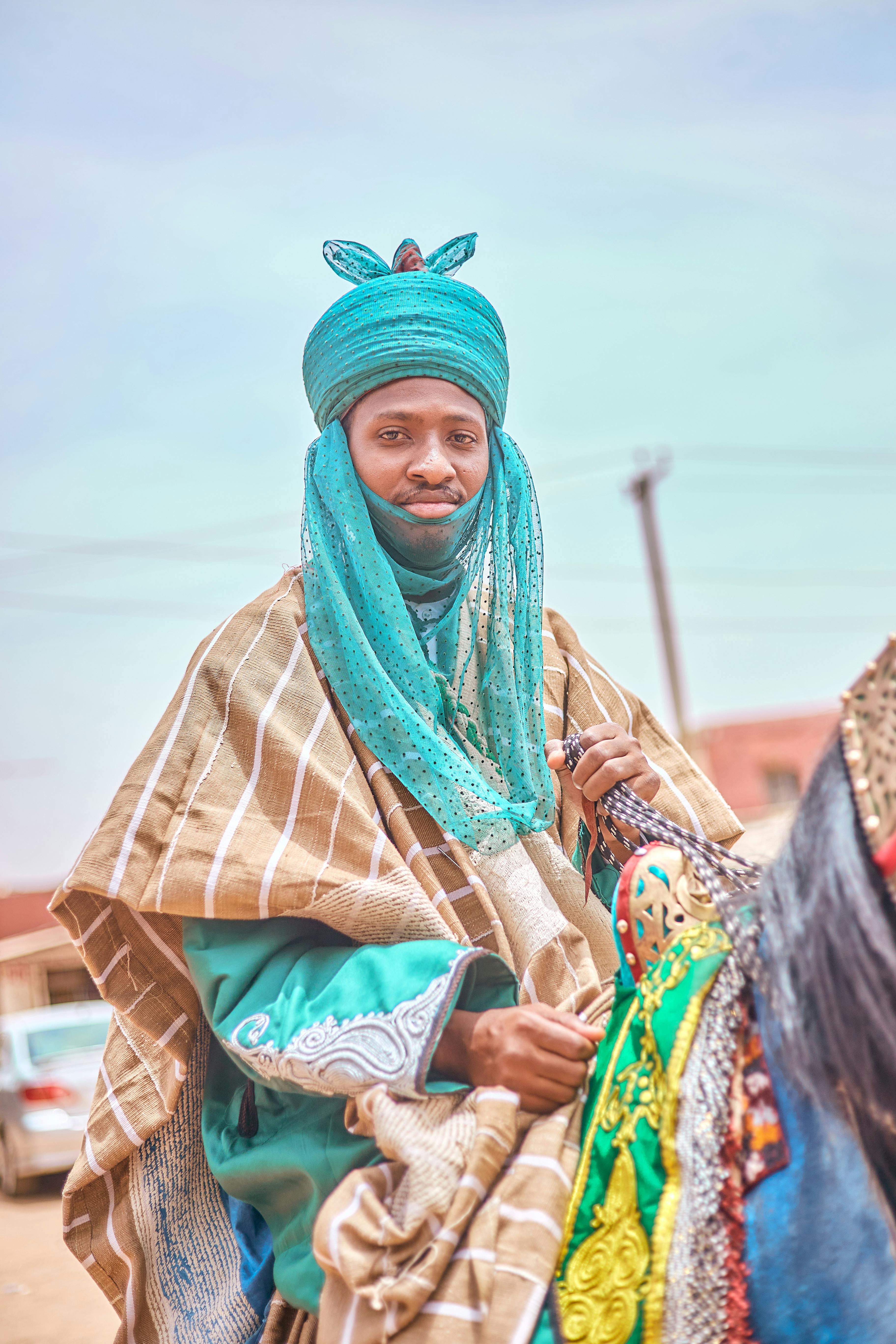African Man in Traditional Garb Riding a Horse · Free Stock Photo