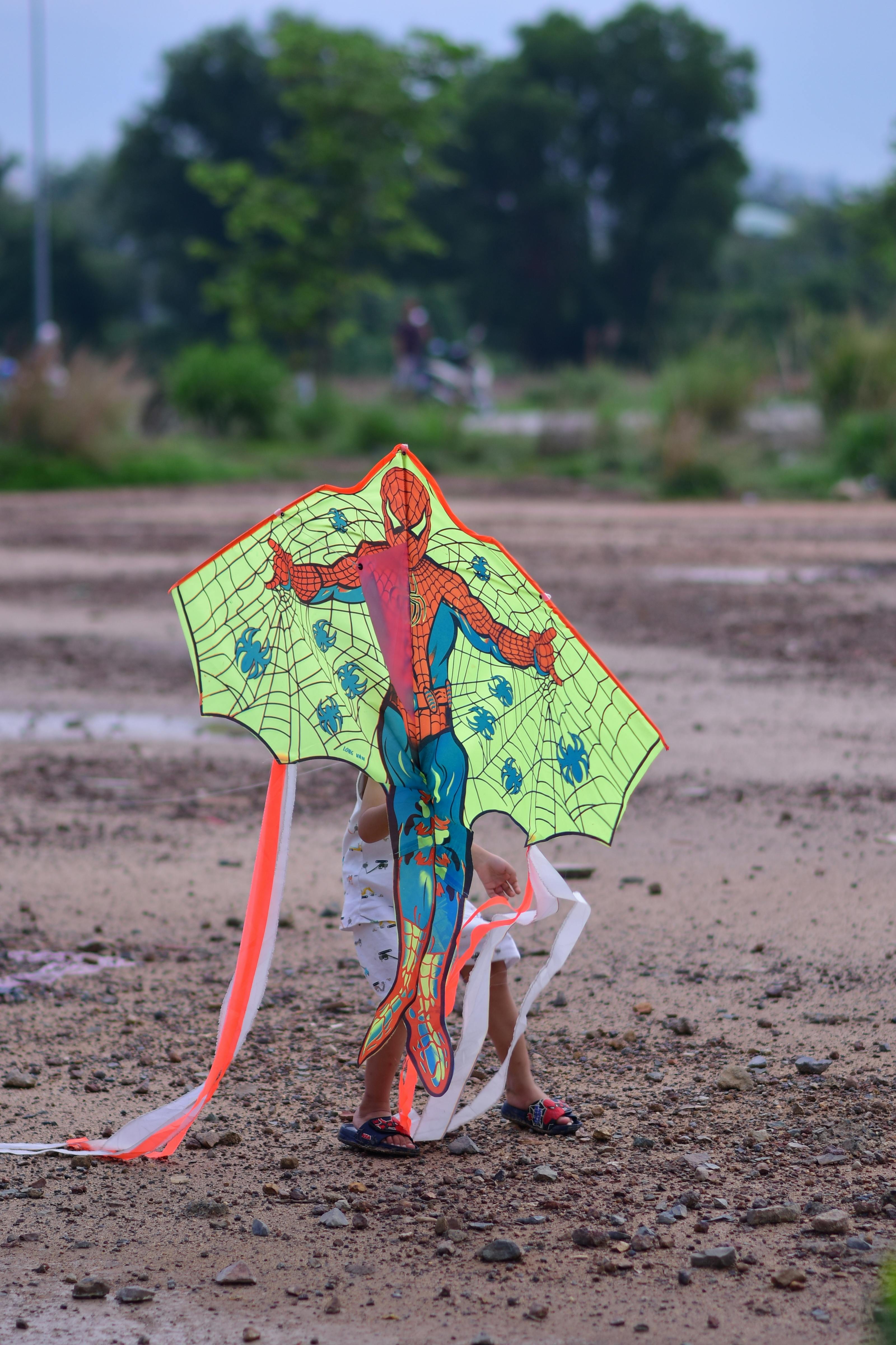 Colorful Kite with Superhero Design Outdoors · Free Stock Photo