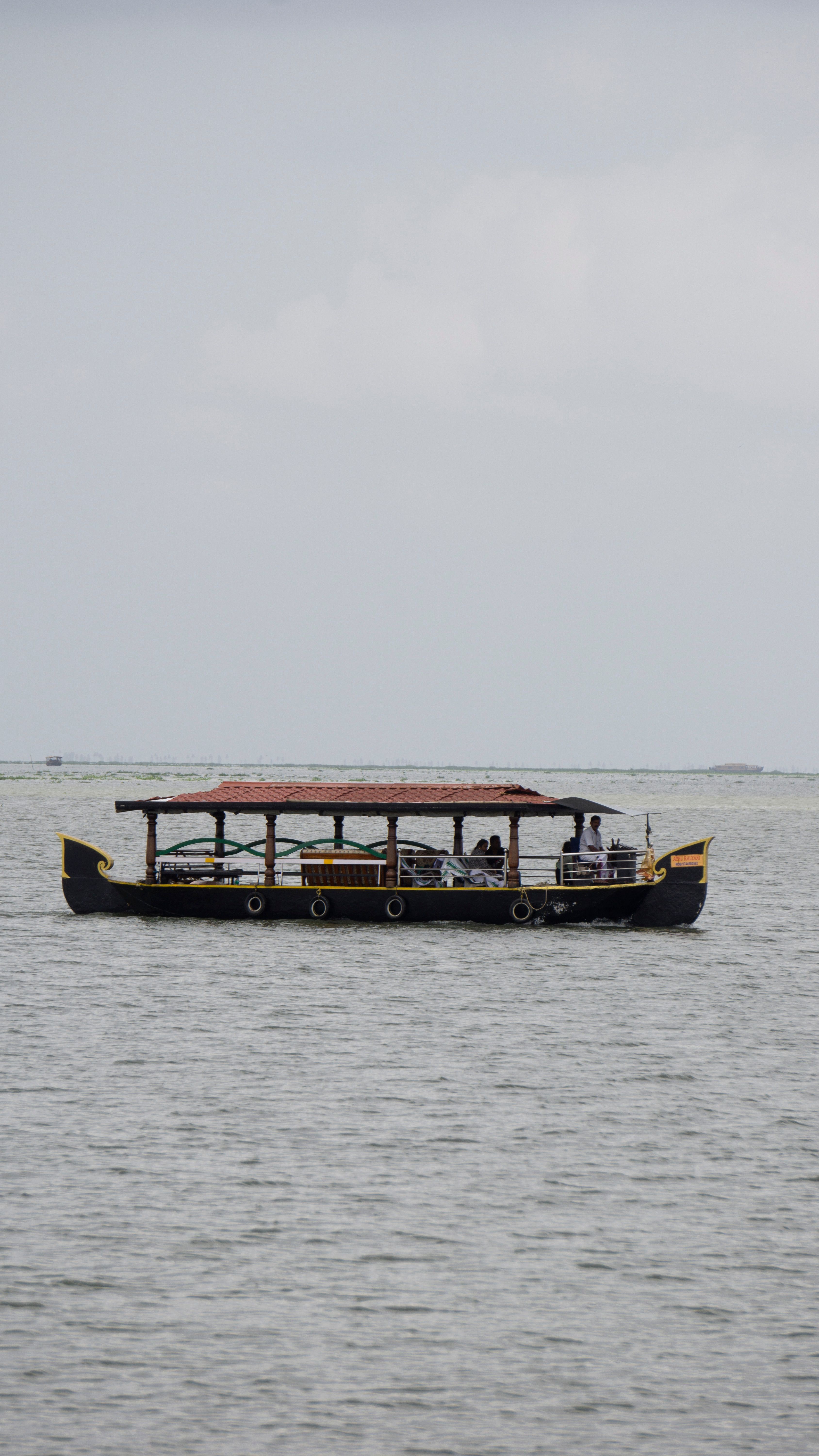 Traditional Boat Floating on Calm Water · Free Stock Photo