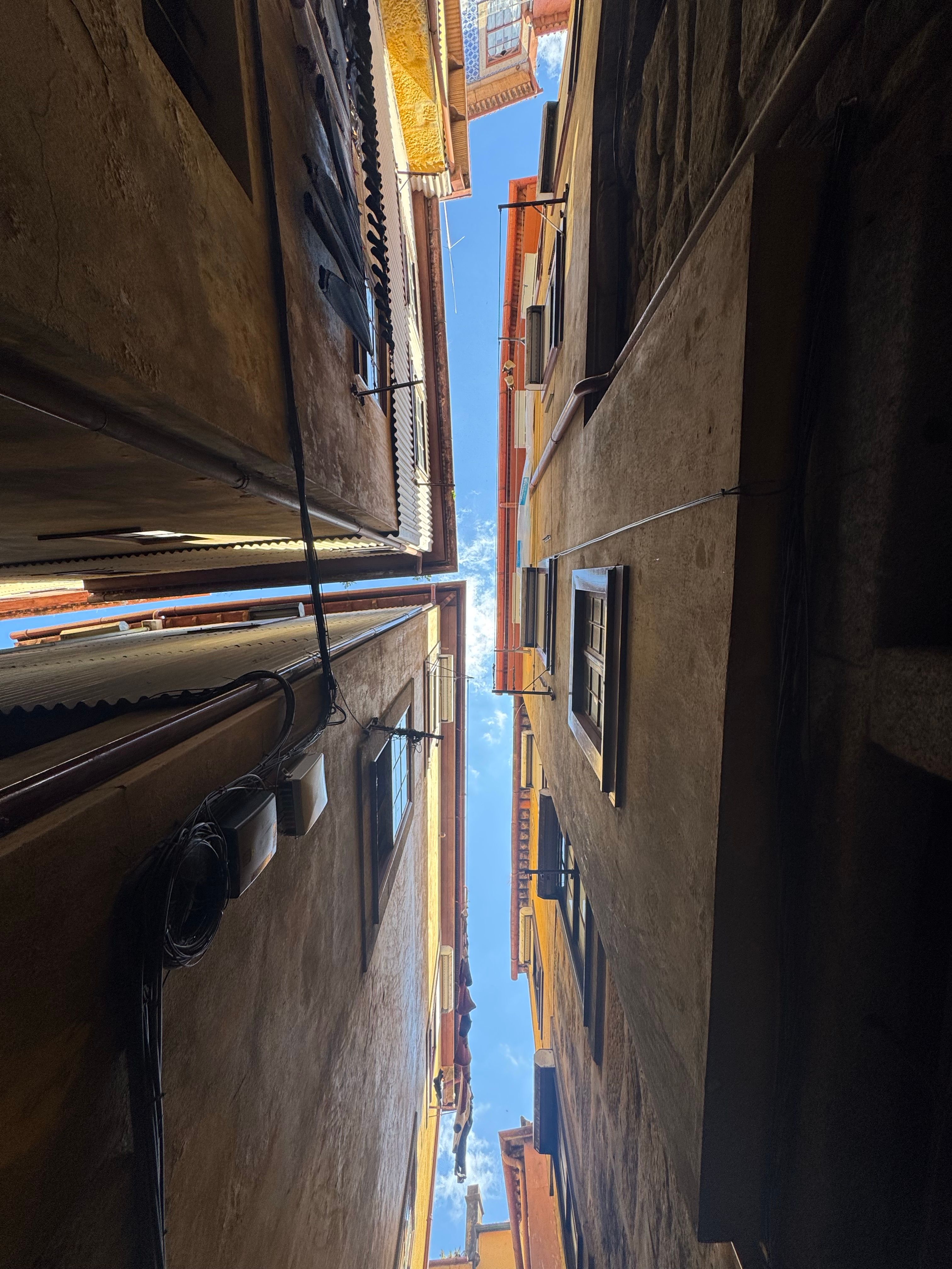 Narrow Alleyway with Blue Sky View · Free Stock Photo