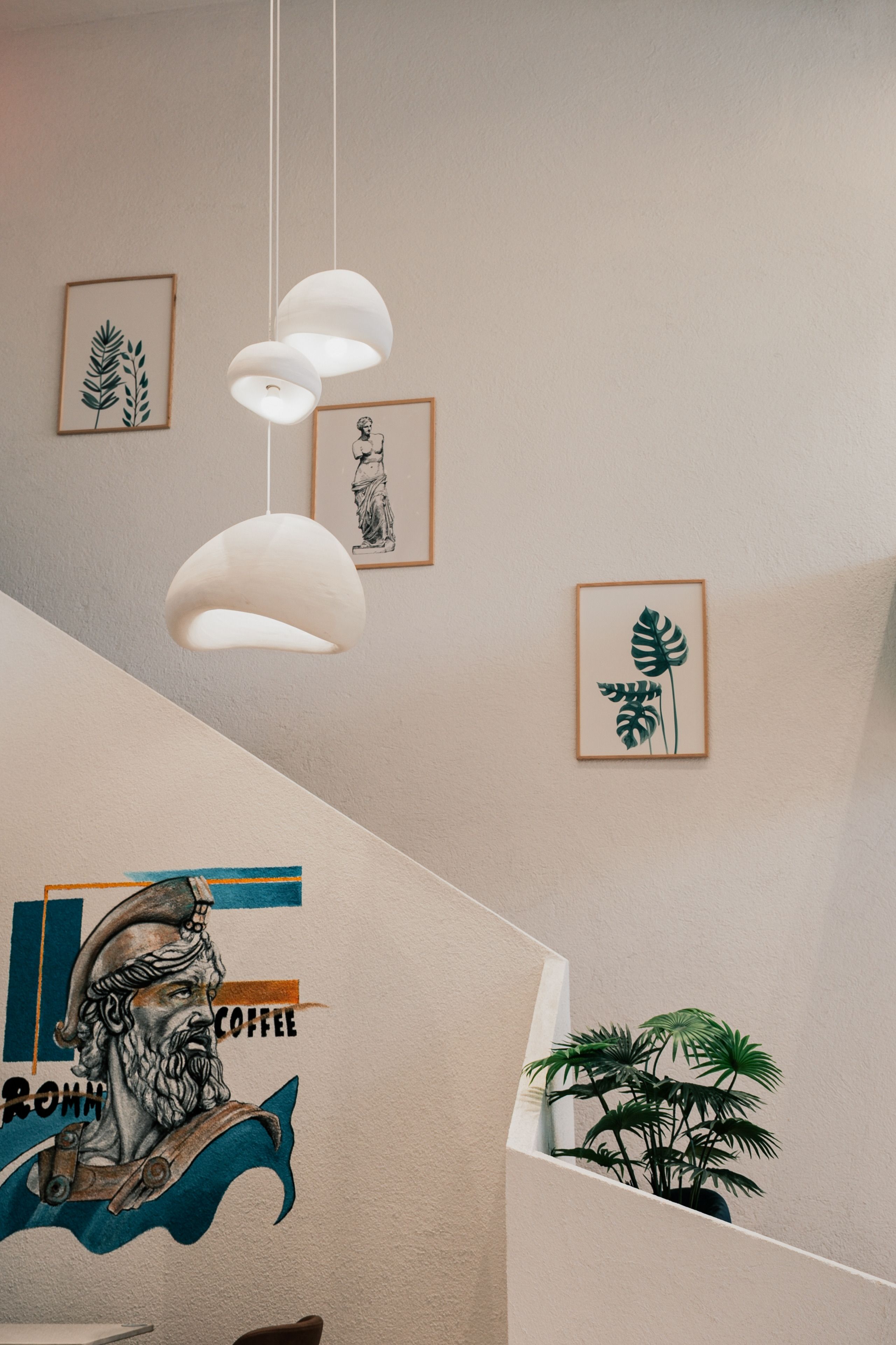 Modern Coffee Shop Interior with Artistic Wall Art · Free Stock Photo