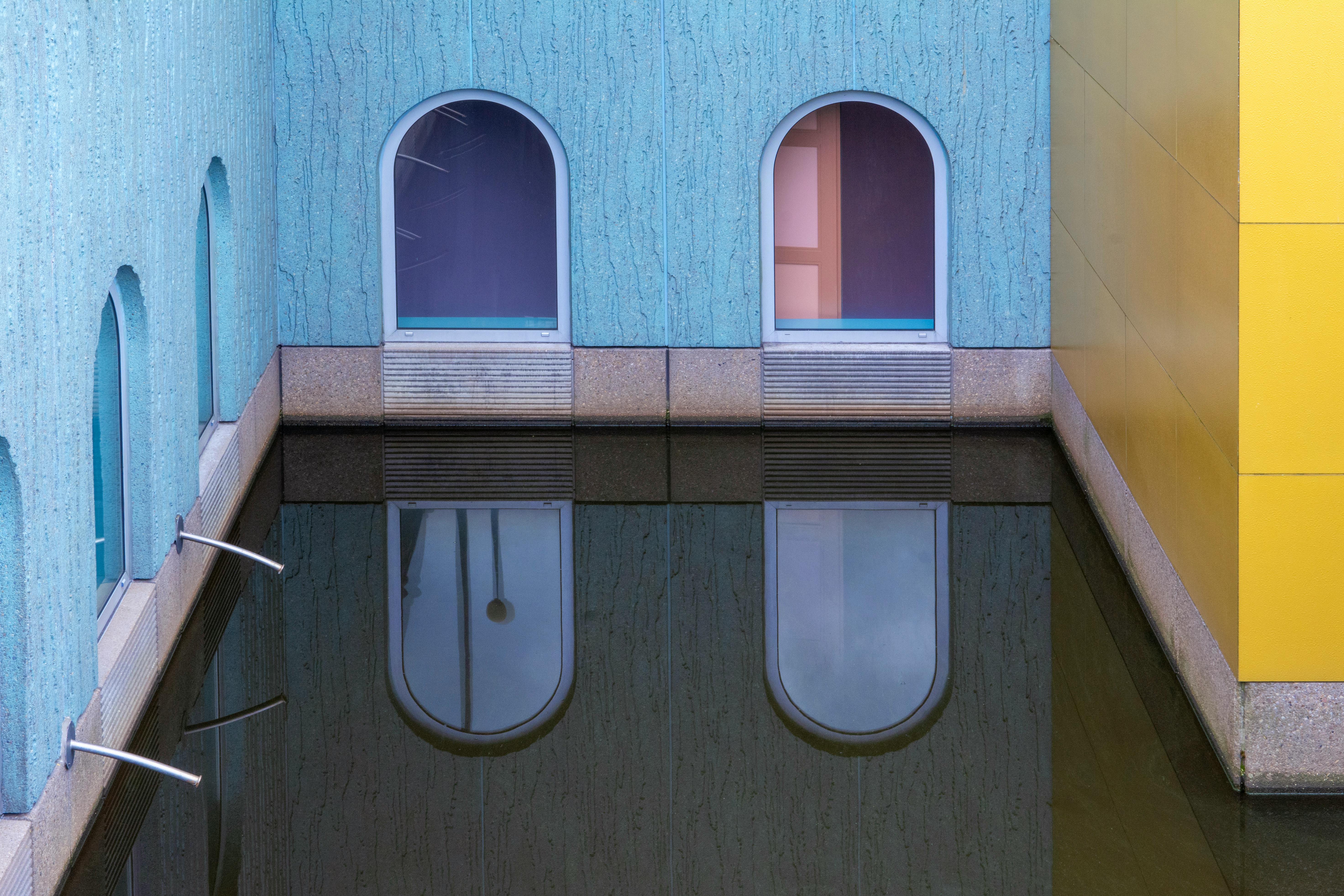 Modern Architectural Reflection with Colorful Facade · Free Stock Photo