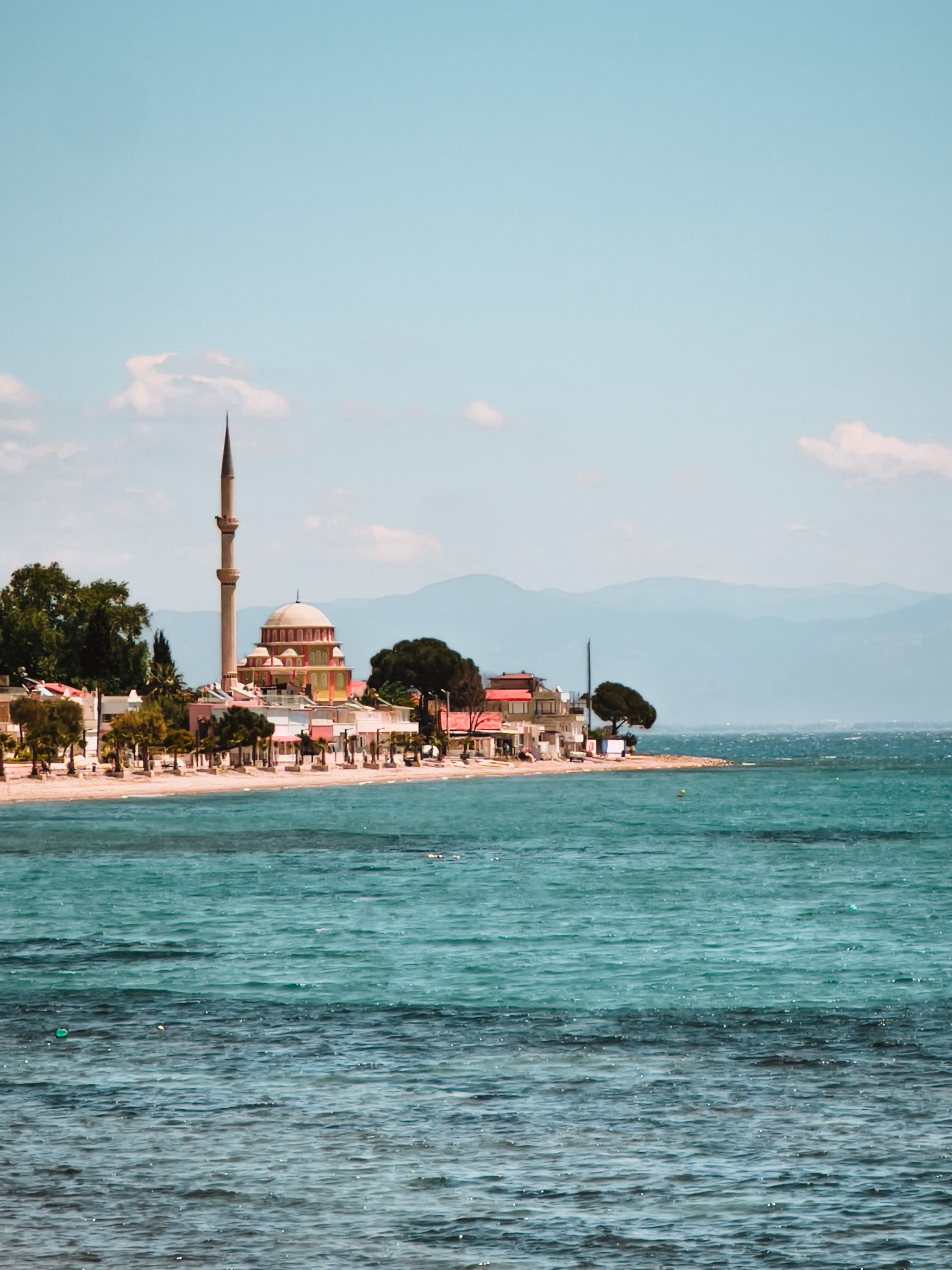 Tranquil Seaside Village with Mosque at Dusk · Free Stock Photo