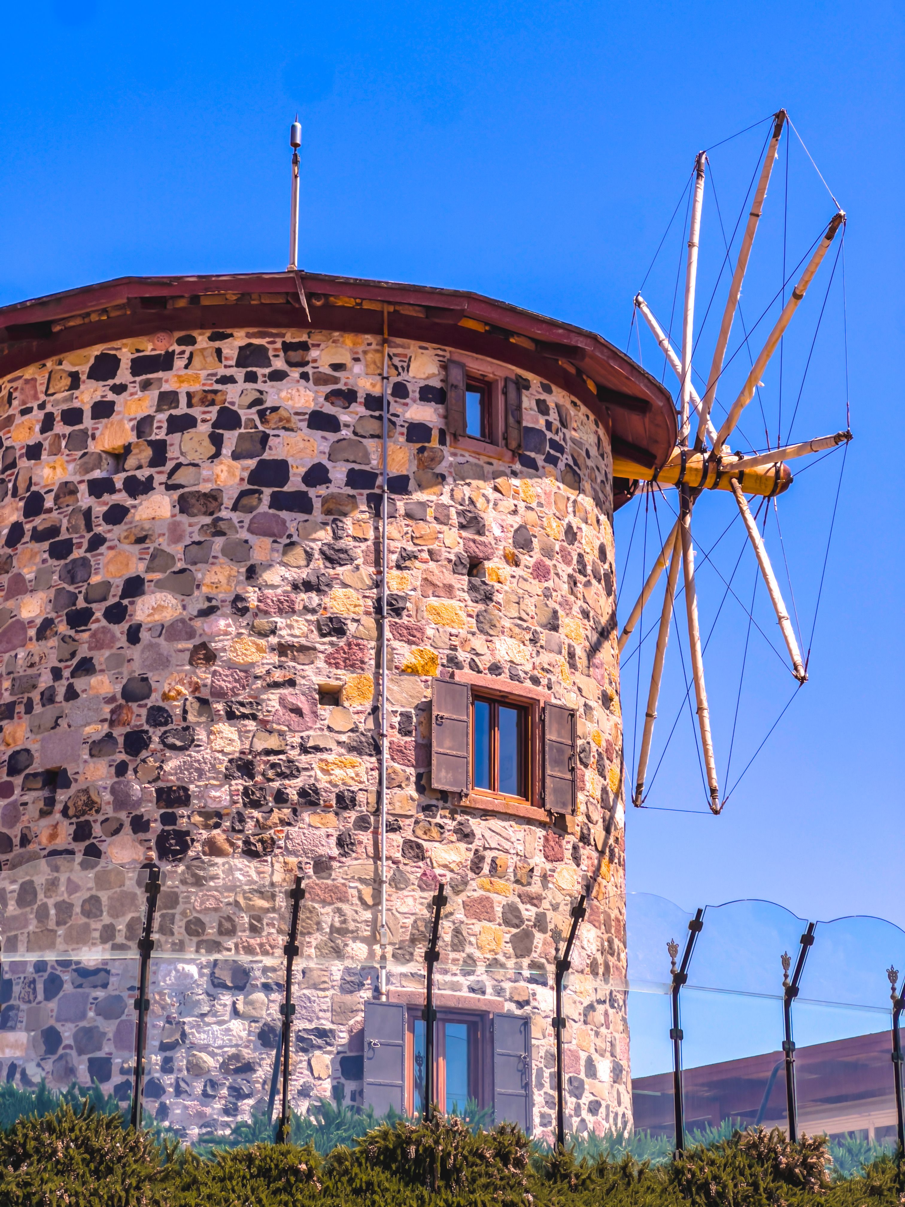 Historic Stone Windmill Against Clear Blue Sky · Free Stock Photo