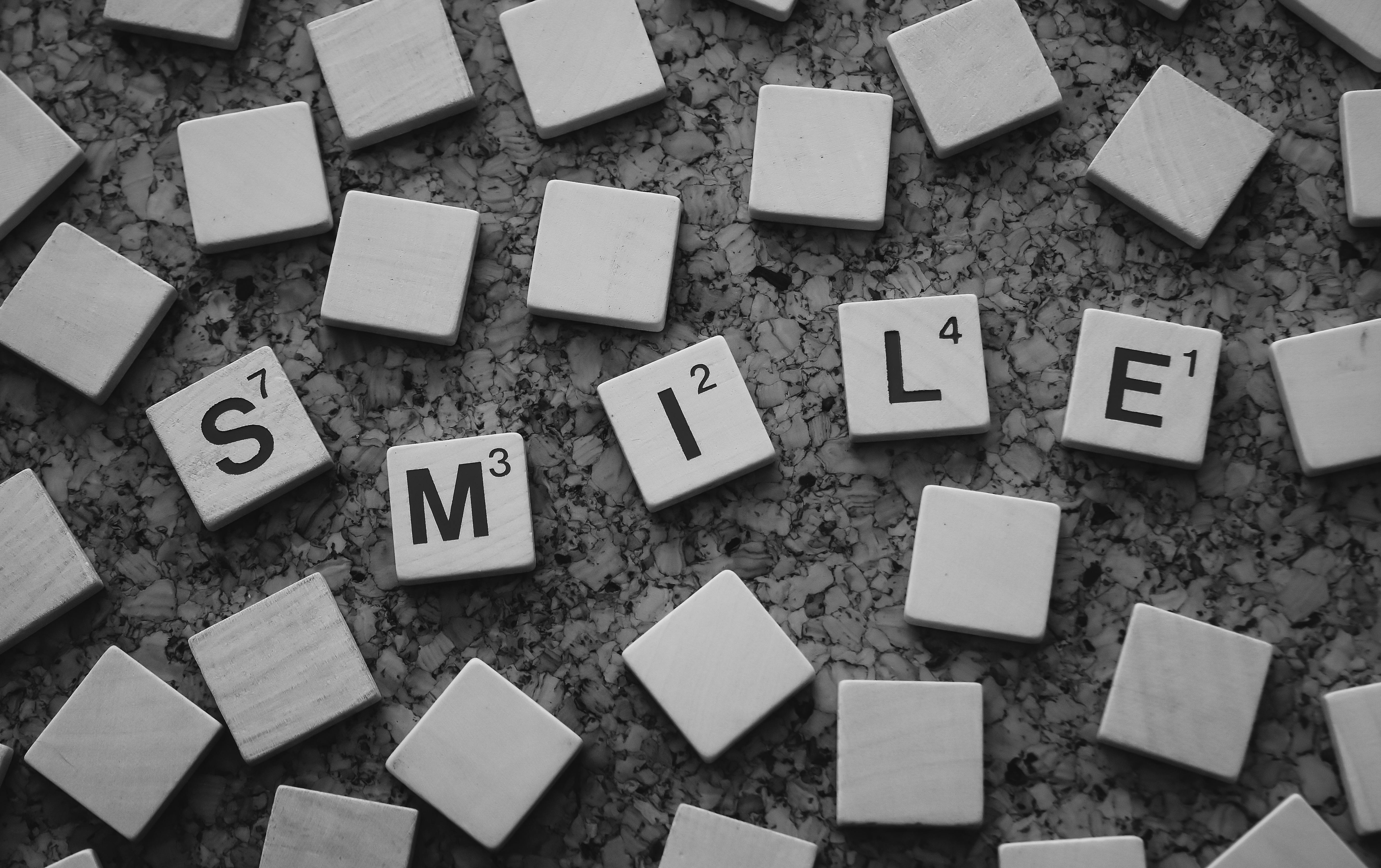 Black and White Scrabble Tiles Spelling 'Smile' · Free Stock Photo