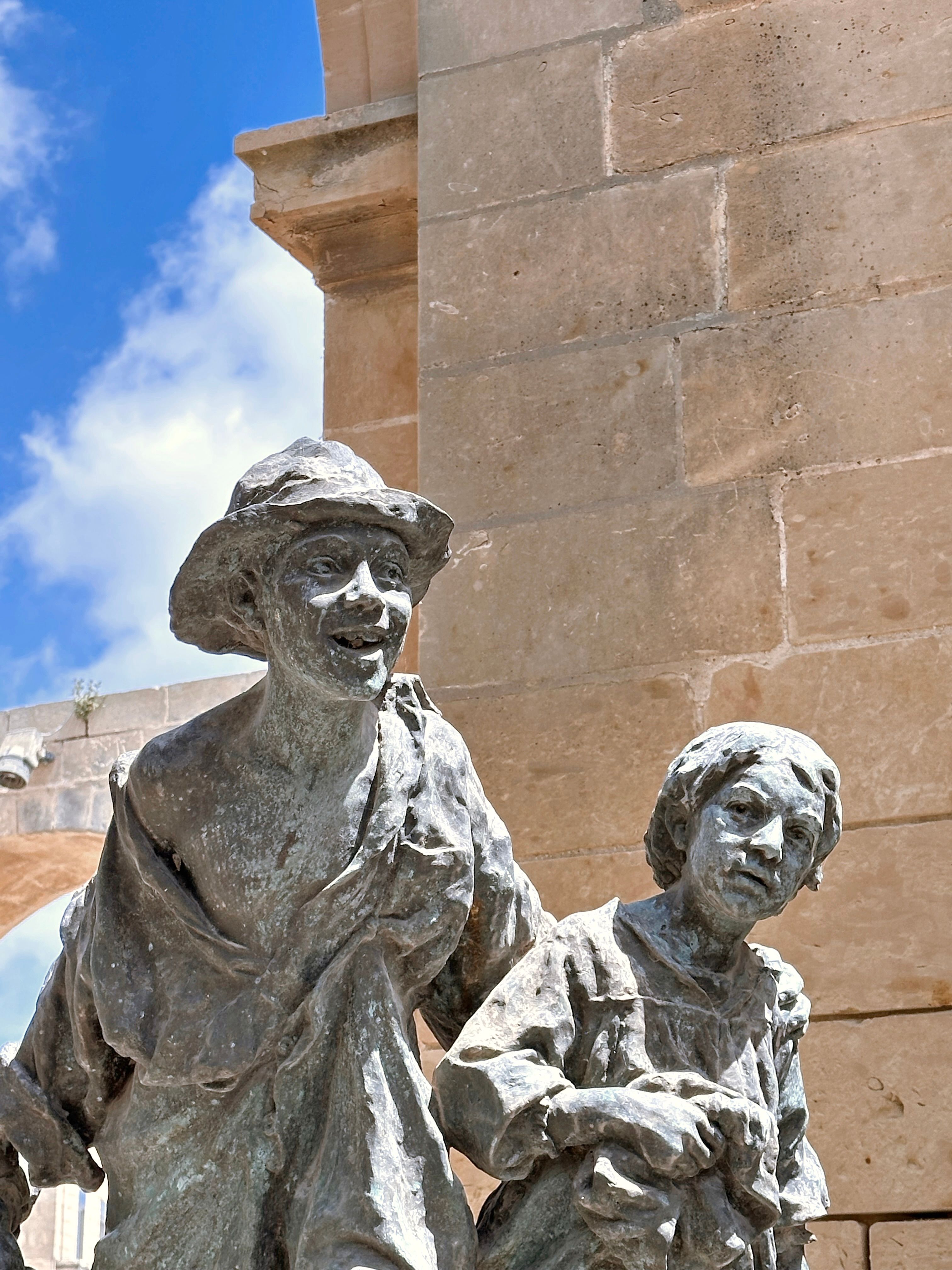 Historic Stone Statues against a Blue Sky · Free Stock Photo