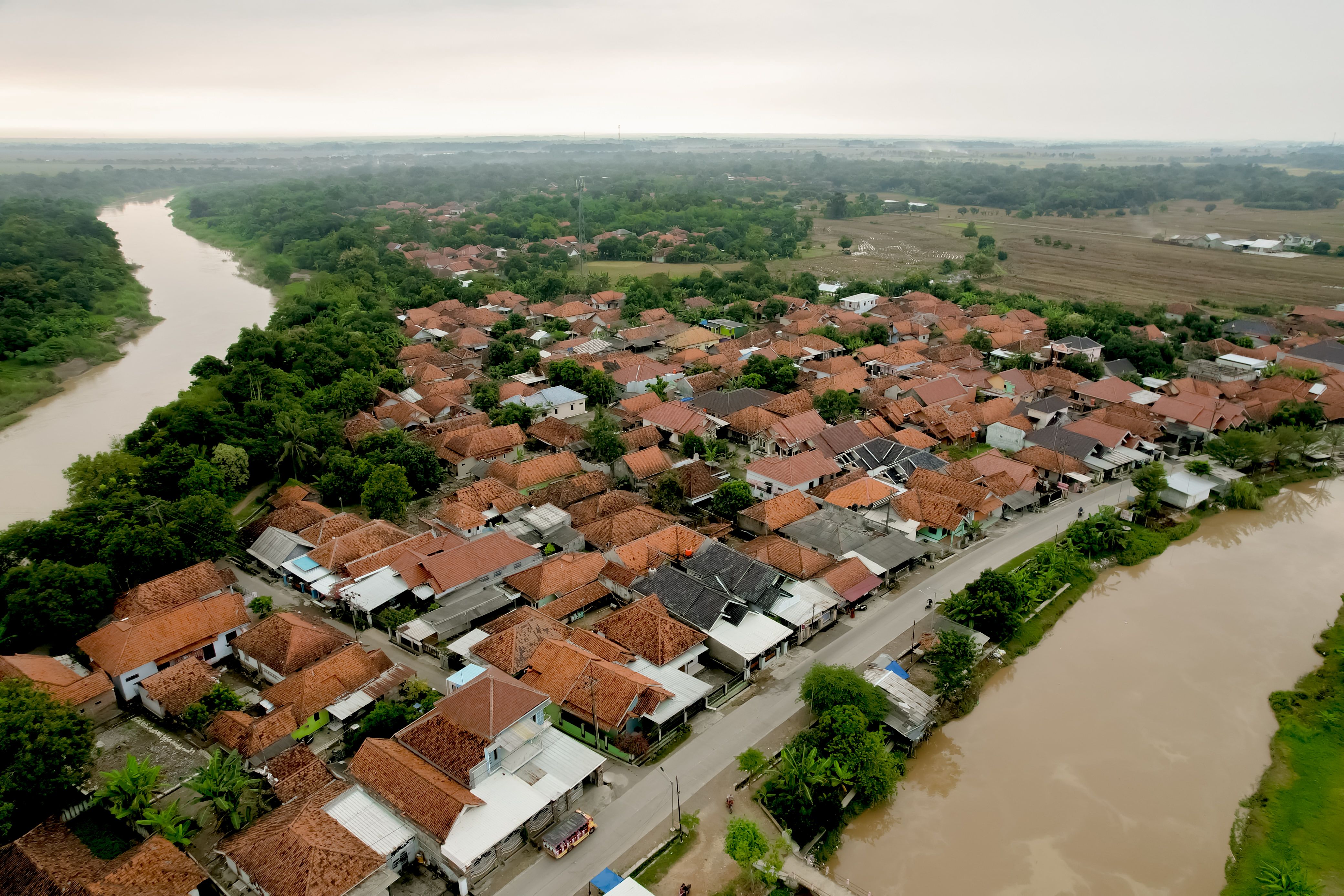 Aerial View of Rural Village with River and Farmland · Free Stock Photo