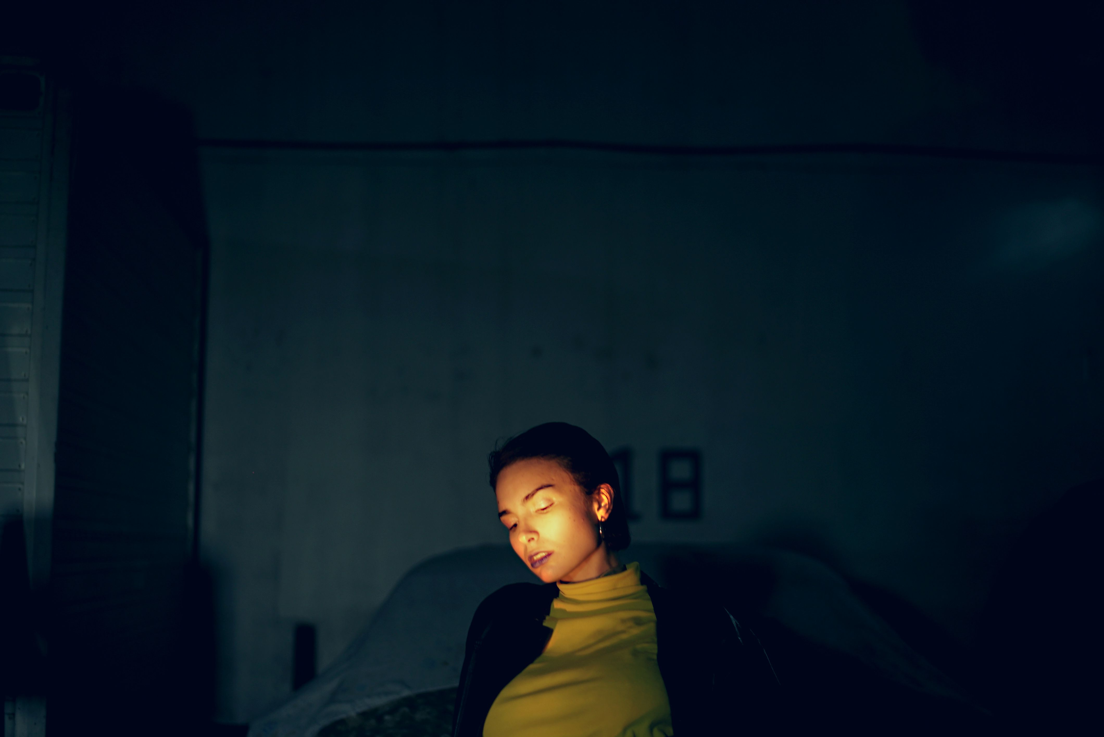Moody Portrait of a Woman in Dim Lighting · Free Stock Photo