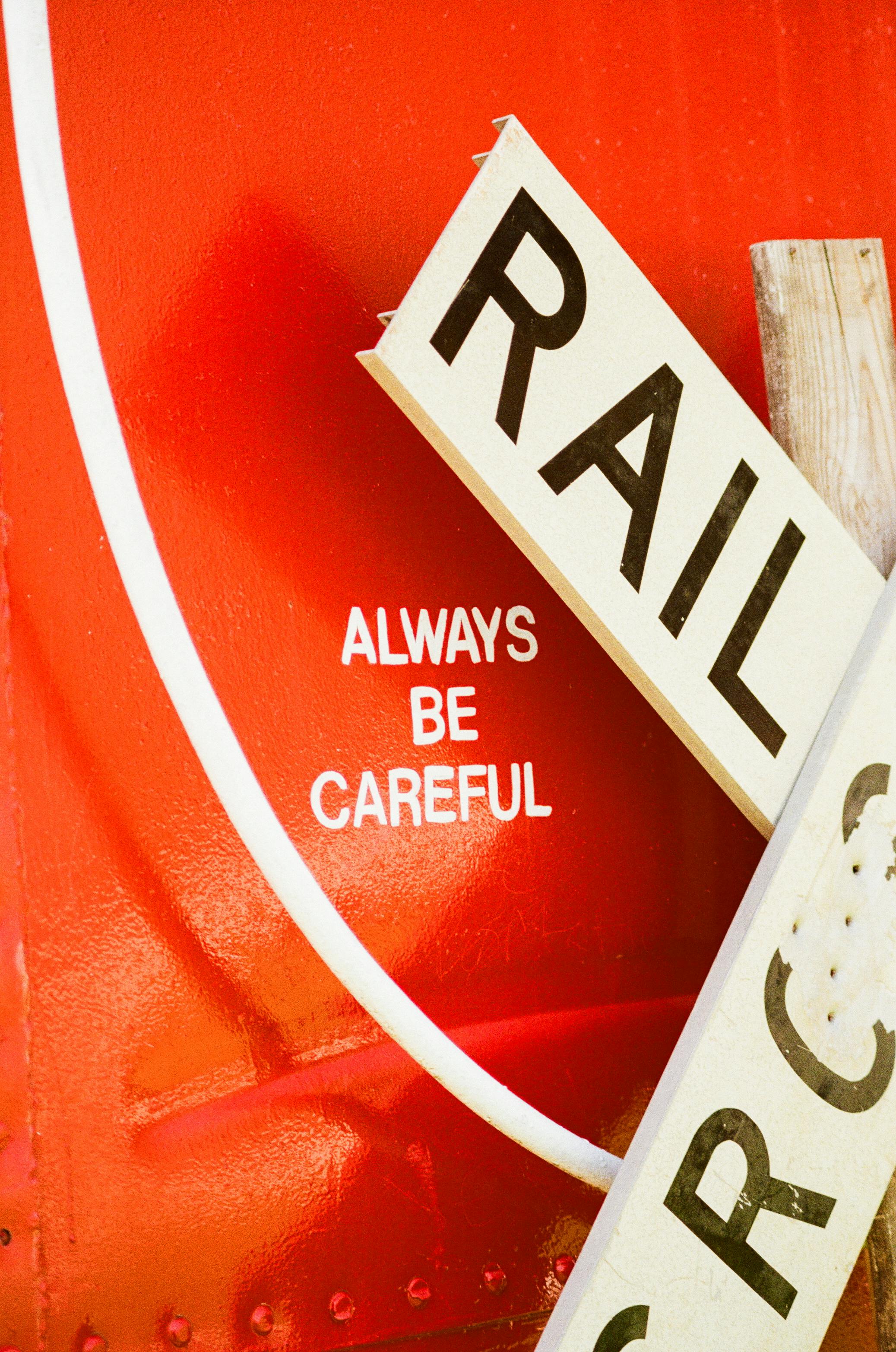 Vivid Red Railroad Warning Sign with Precaution · Free Stock Photo
