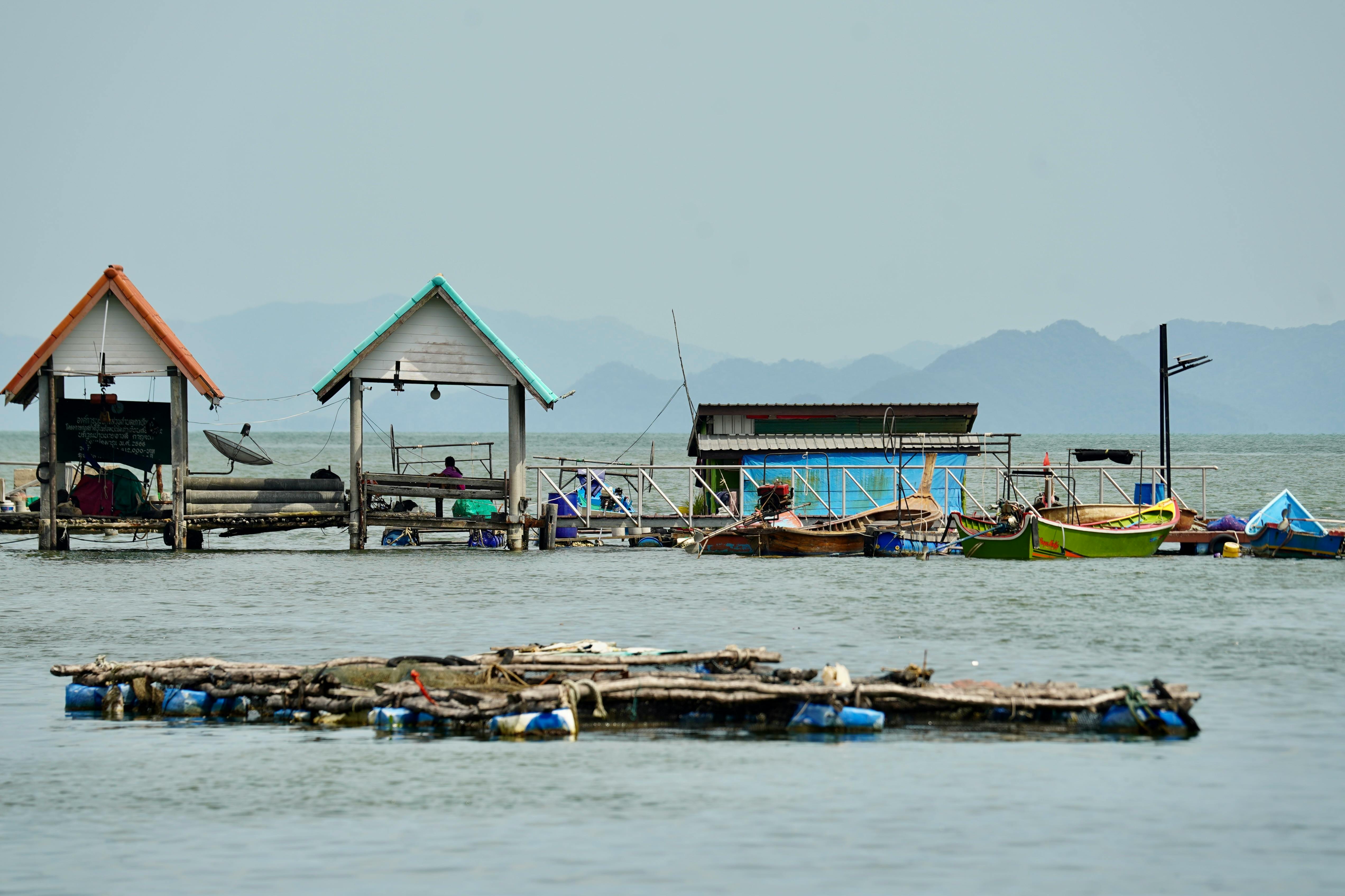Traditional Fishing Village on Serene Waterfront · Free Stock Photo