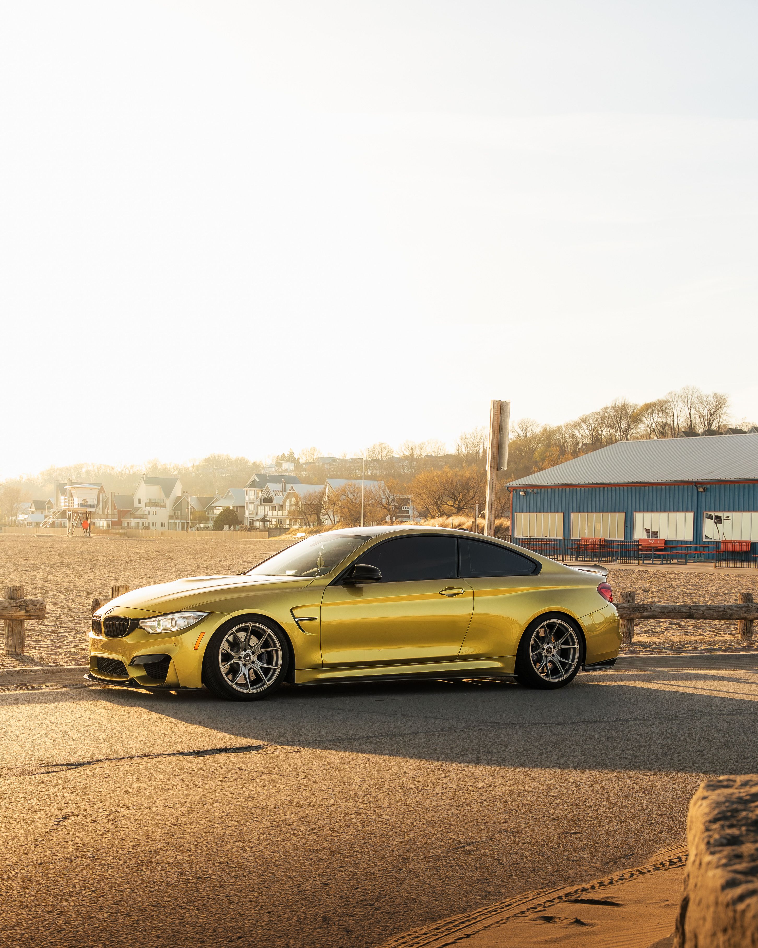 Sleek Gold Sports Car by the Beach at Sunset · Free Stock Photo