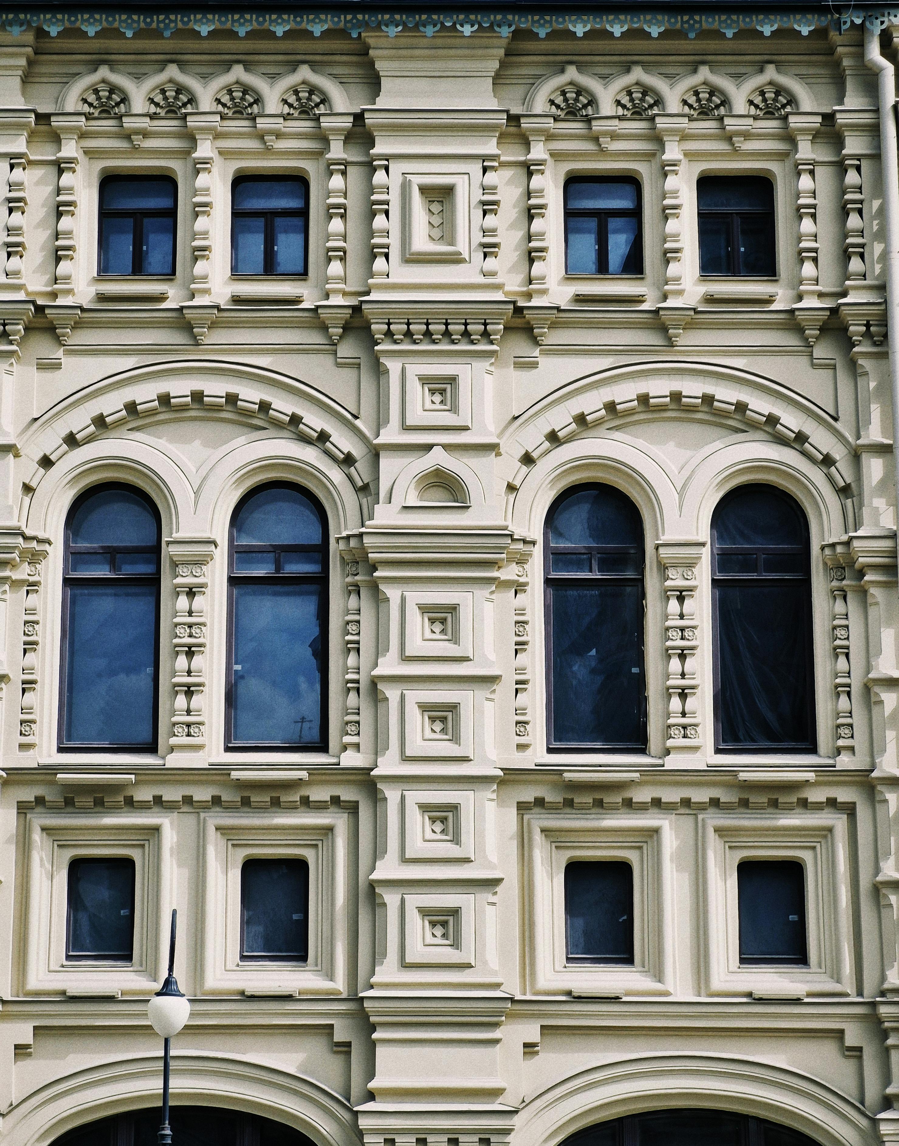 Ornate Classical Building Facade with Arched Windows · Free Stock Photo