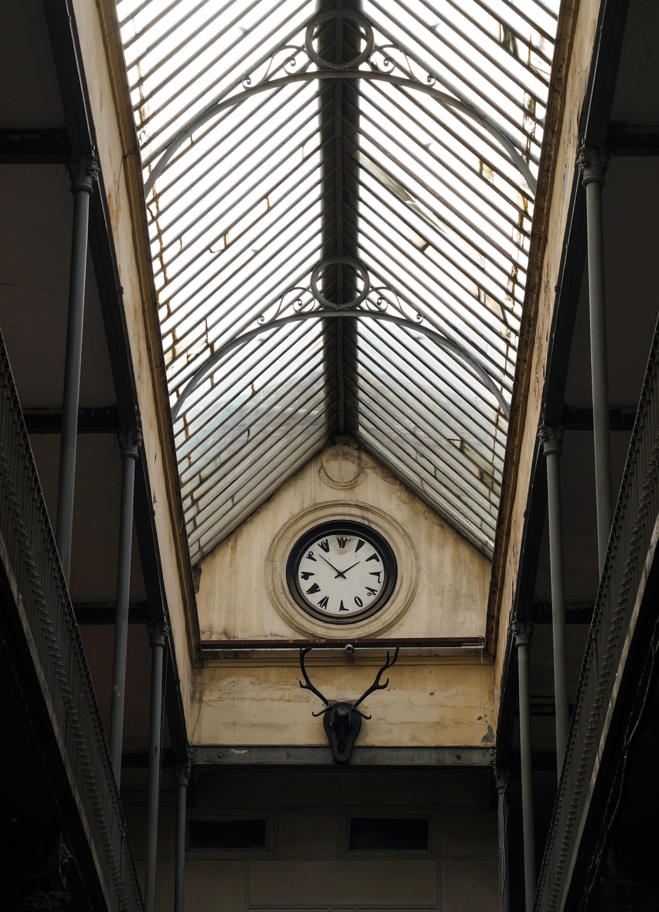 Elegant Indoor Passage with Clock and Glass Roof · Free Stock Photo