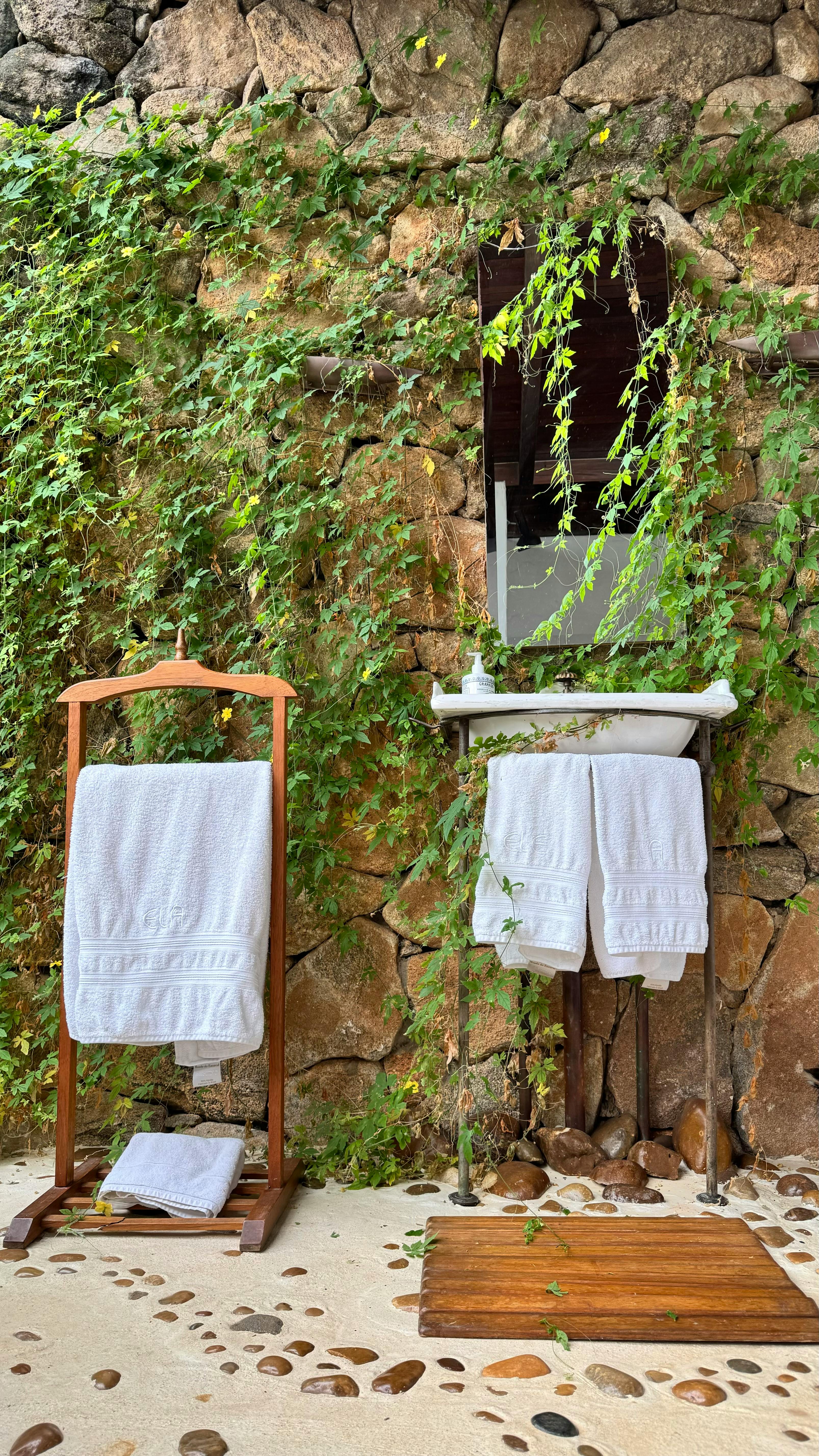 Rustic Outdoor Bathroom with Stone Wall · Free Stock Photo