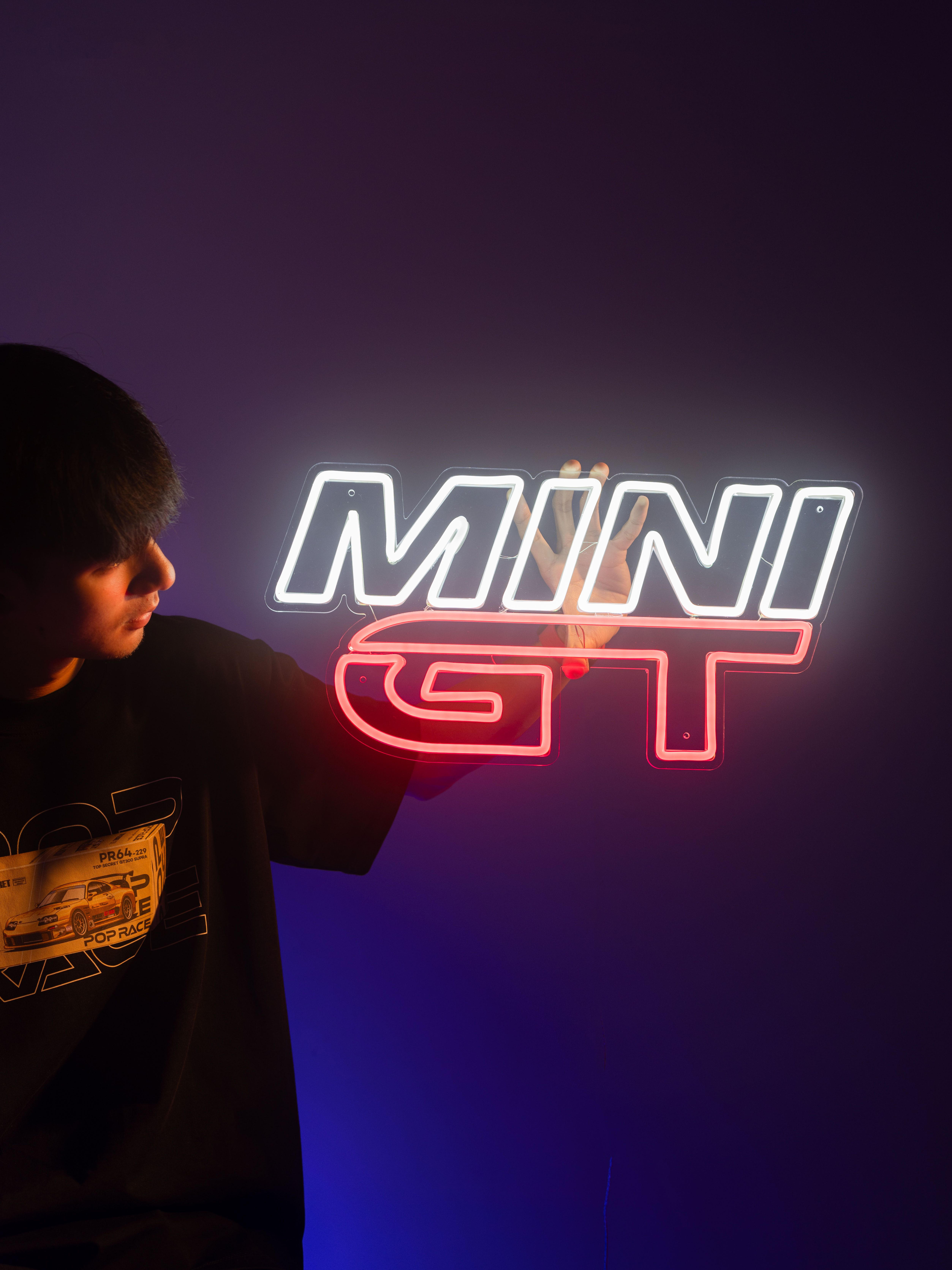 Person Holding Mini GT Neon Sign in Dark Room · Free Stock Photo