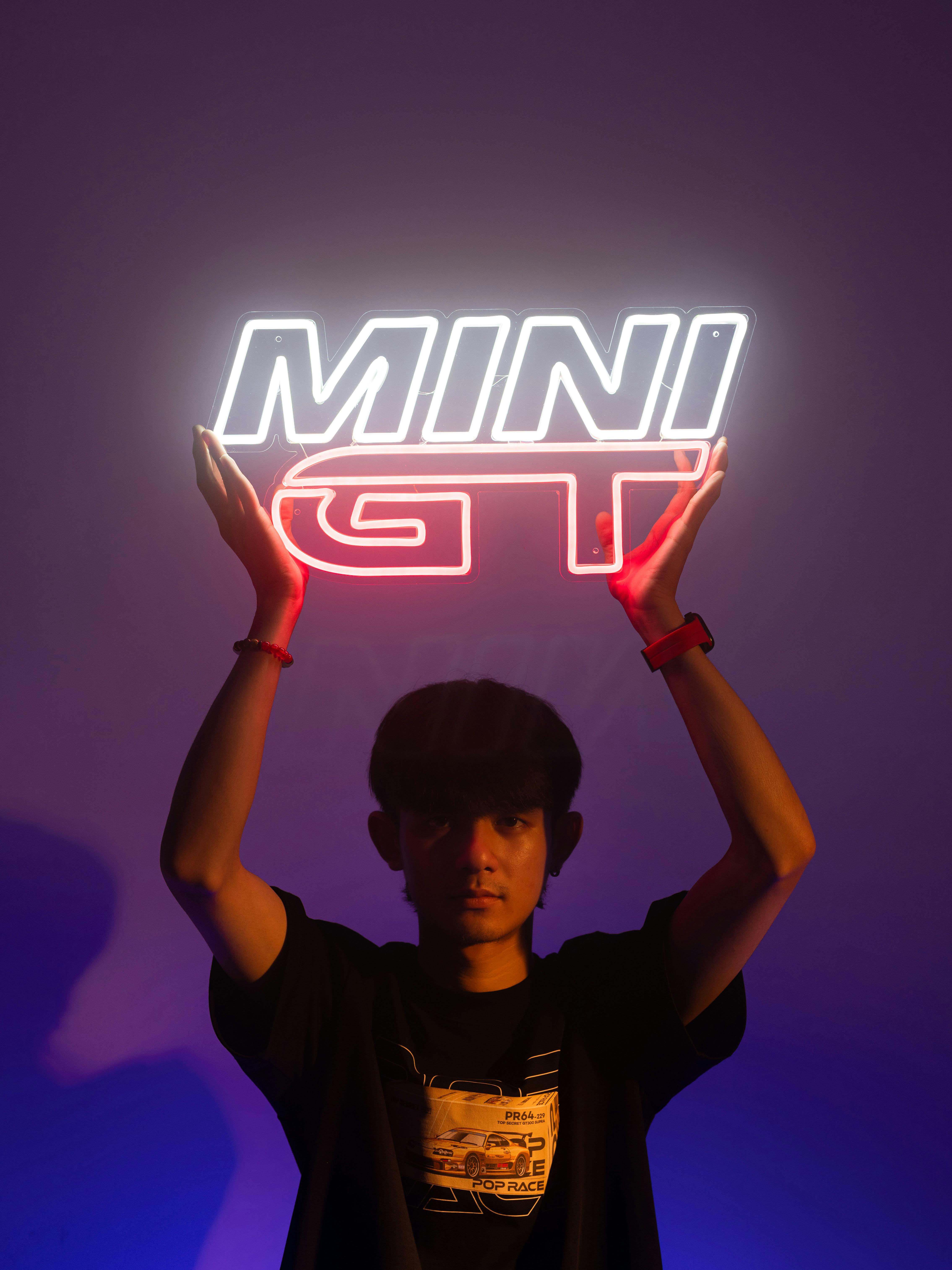 Person Holding Neon Mini GT Sign in Phnom Penh · Free Stock Photo