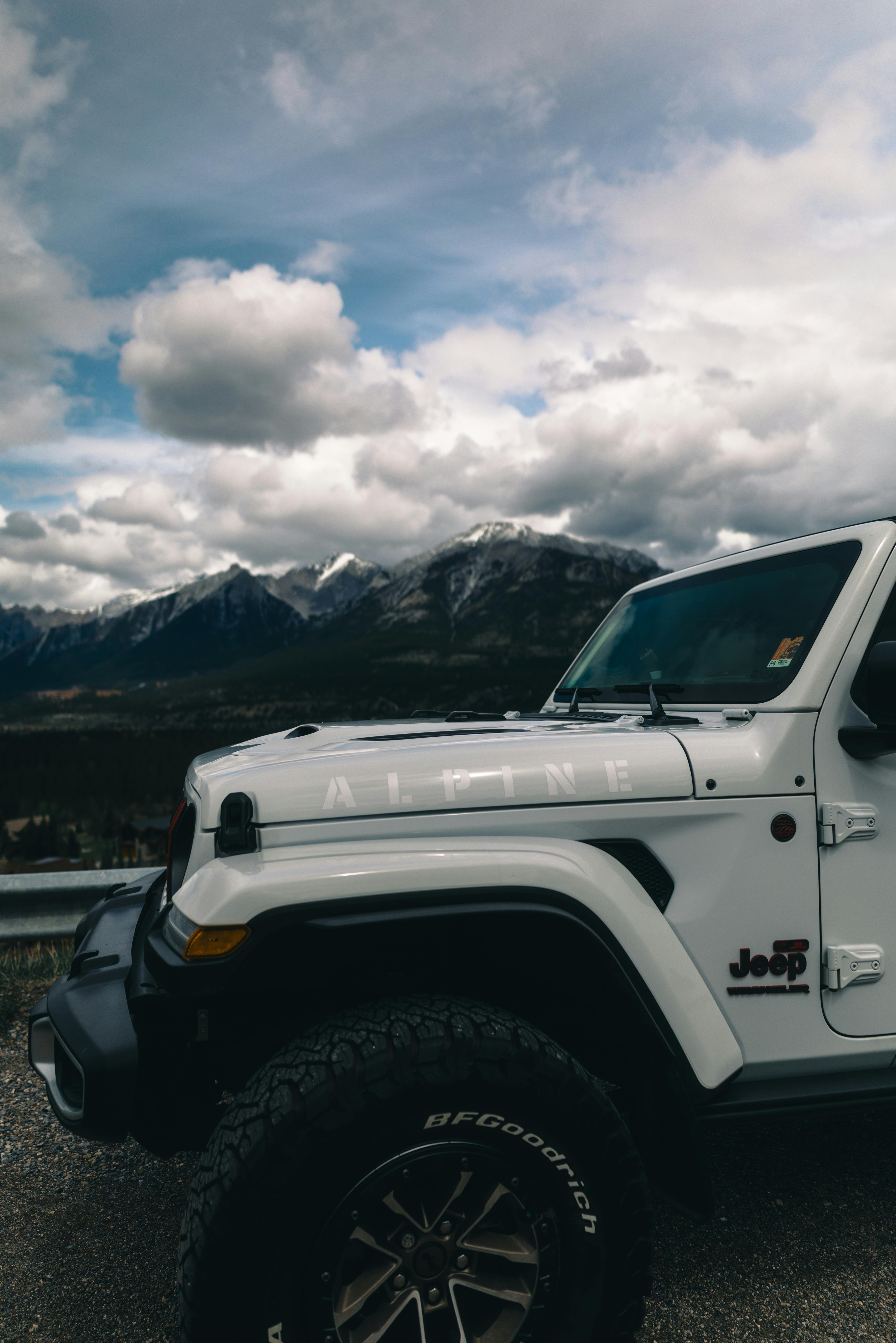 White Jeep Parked Overlooking Canadian Rockies · Free Stock Photo