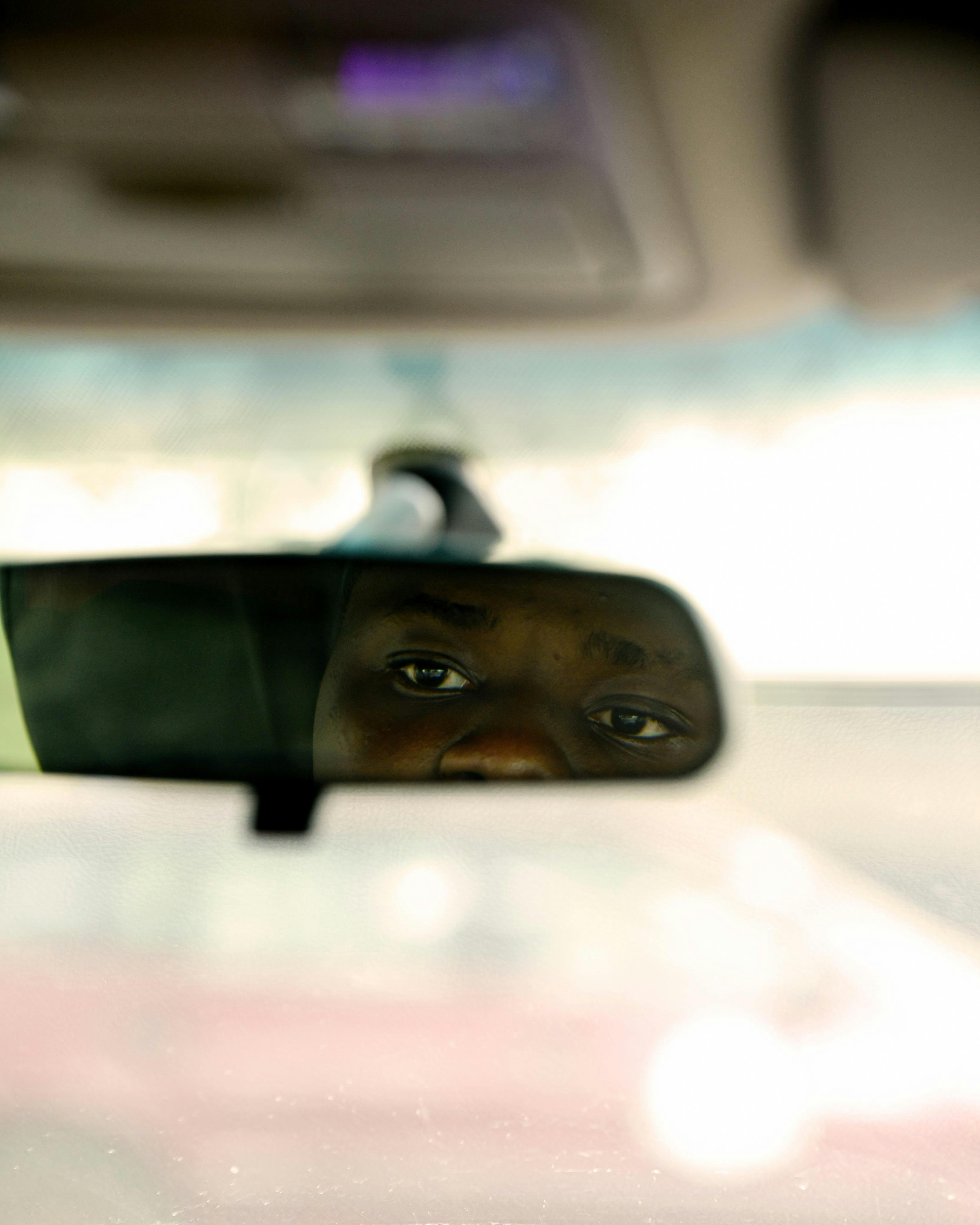 Close-up of Eyes in Rearview Mirror Reflection · Free Stock Photo