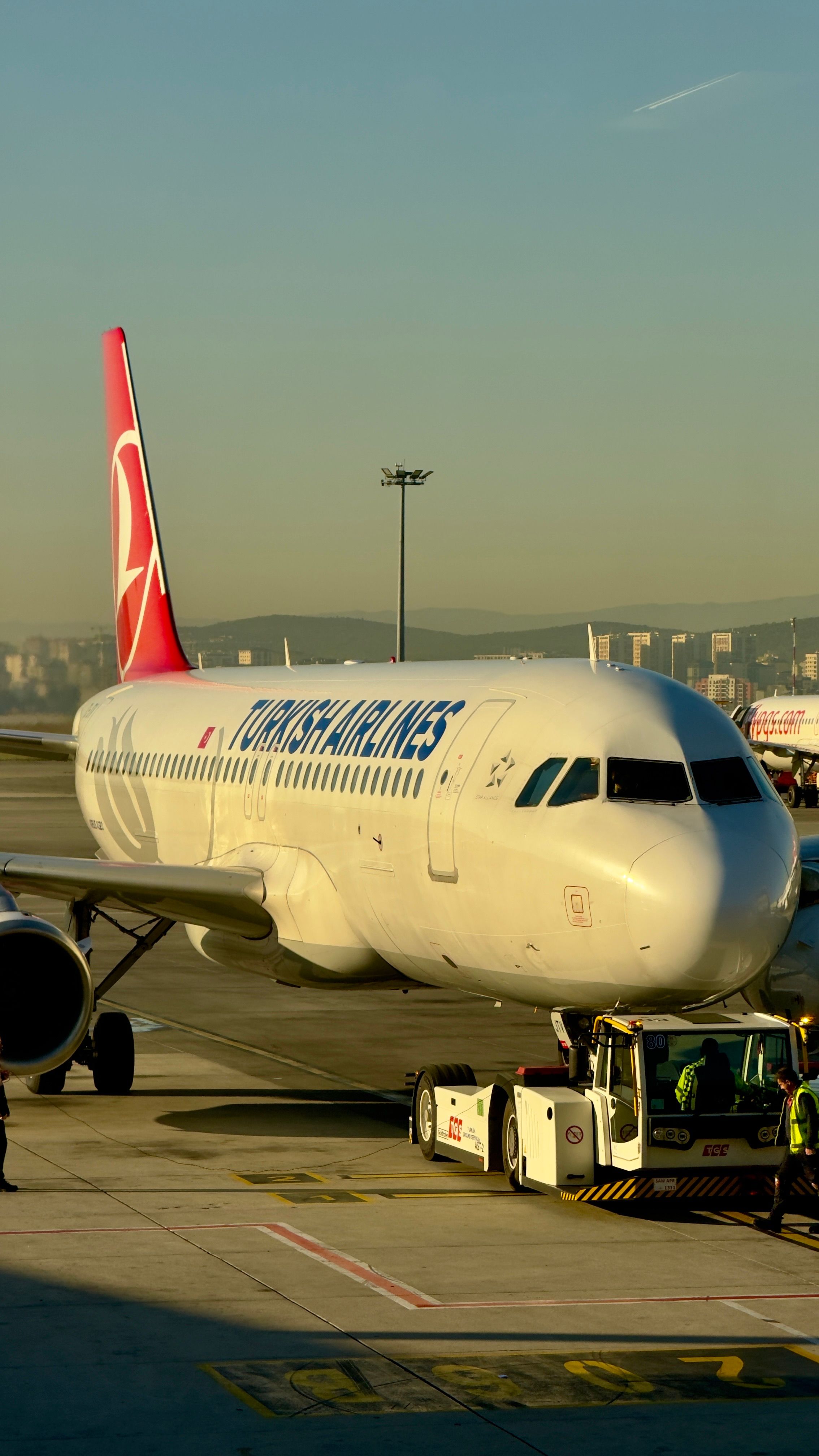 Turkish Airlines Plane on Sunny Airport Tarmac · Free Stock Photo