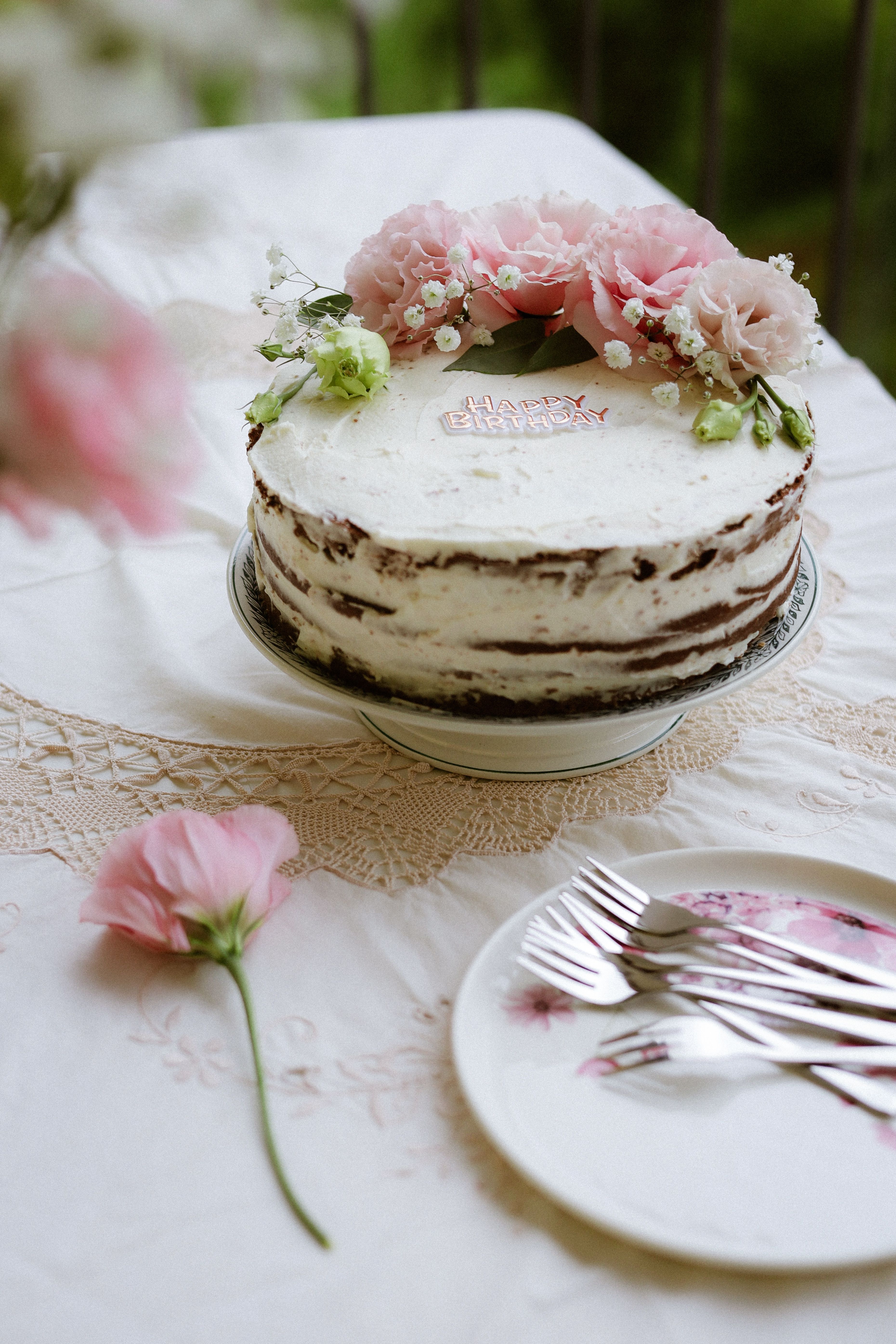Elegant Floral Birthday Cake at Outdoor Celebration · Free Stock Photo