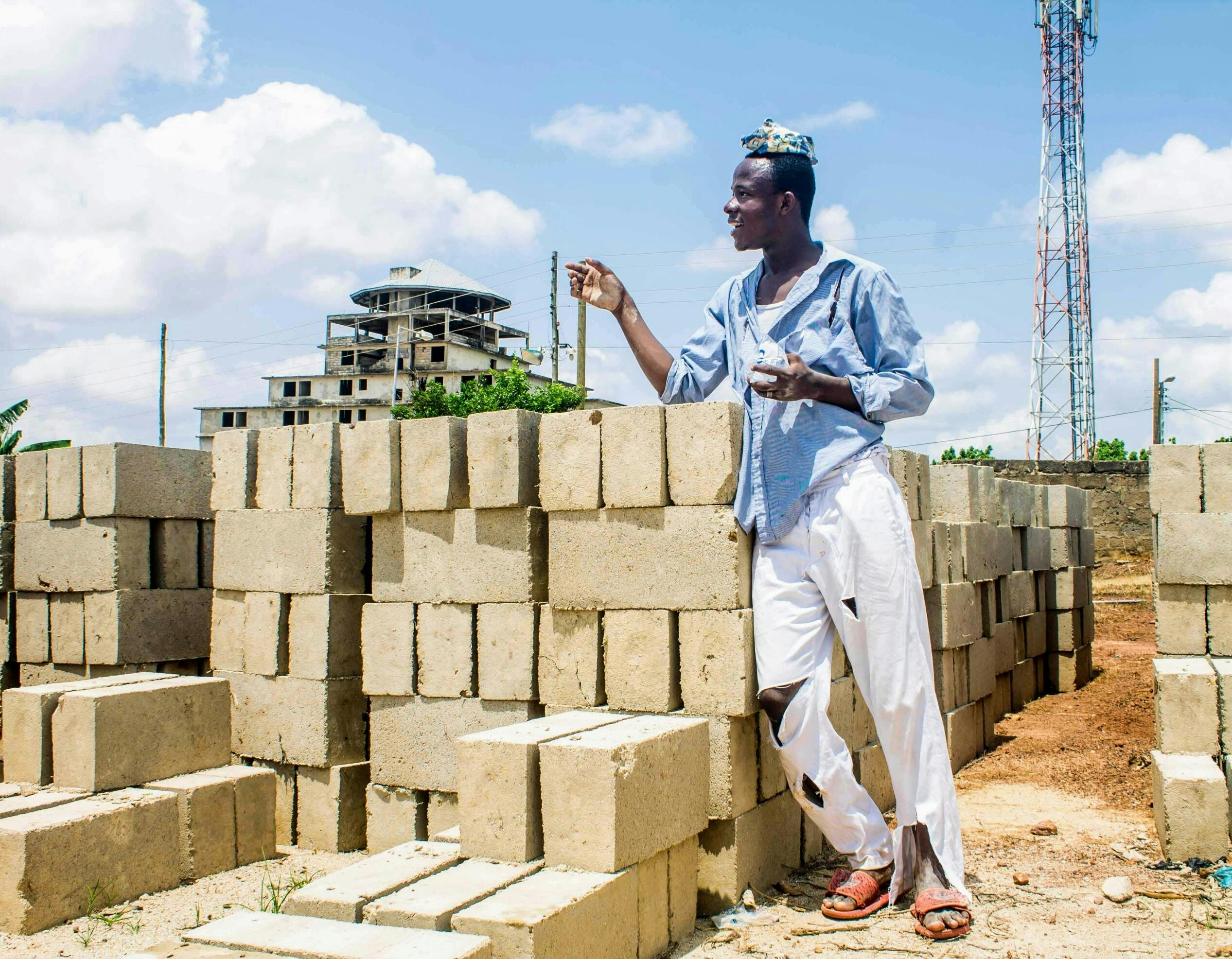 Young Man at Construction Site with Building Blocks · Free Stock Photo