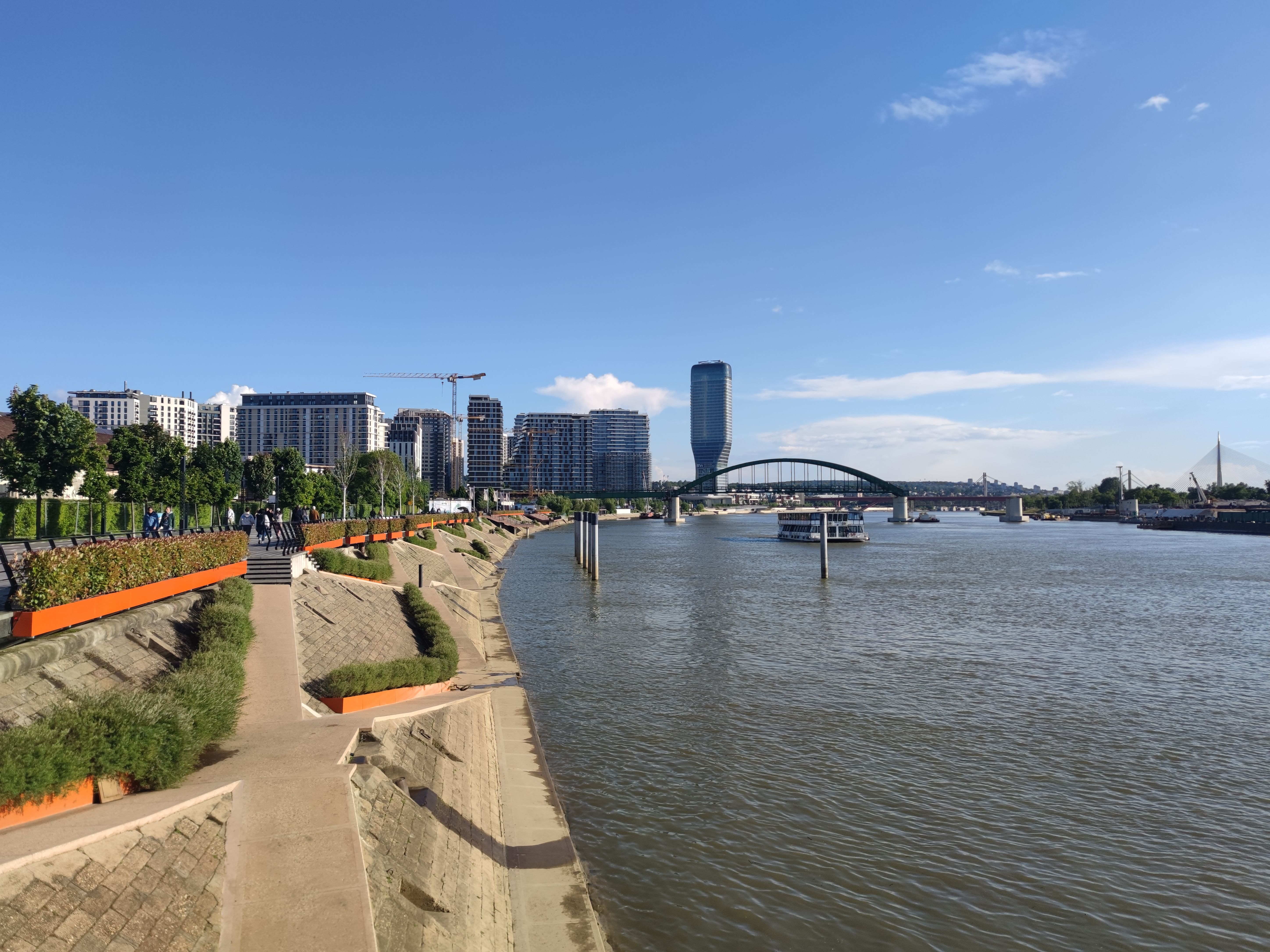 Scenic Riverside View with Modern Cityscape · Free Stock Photo