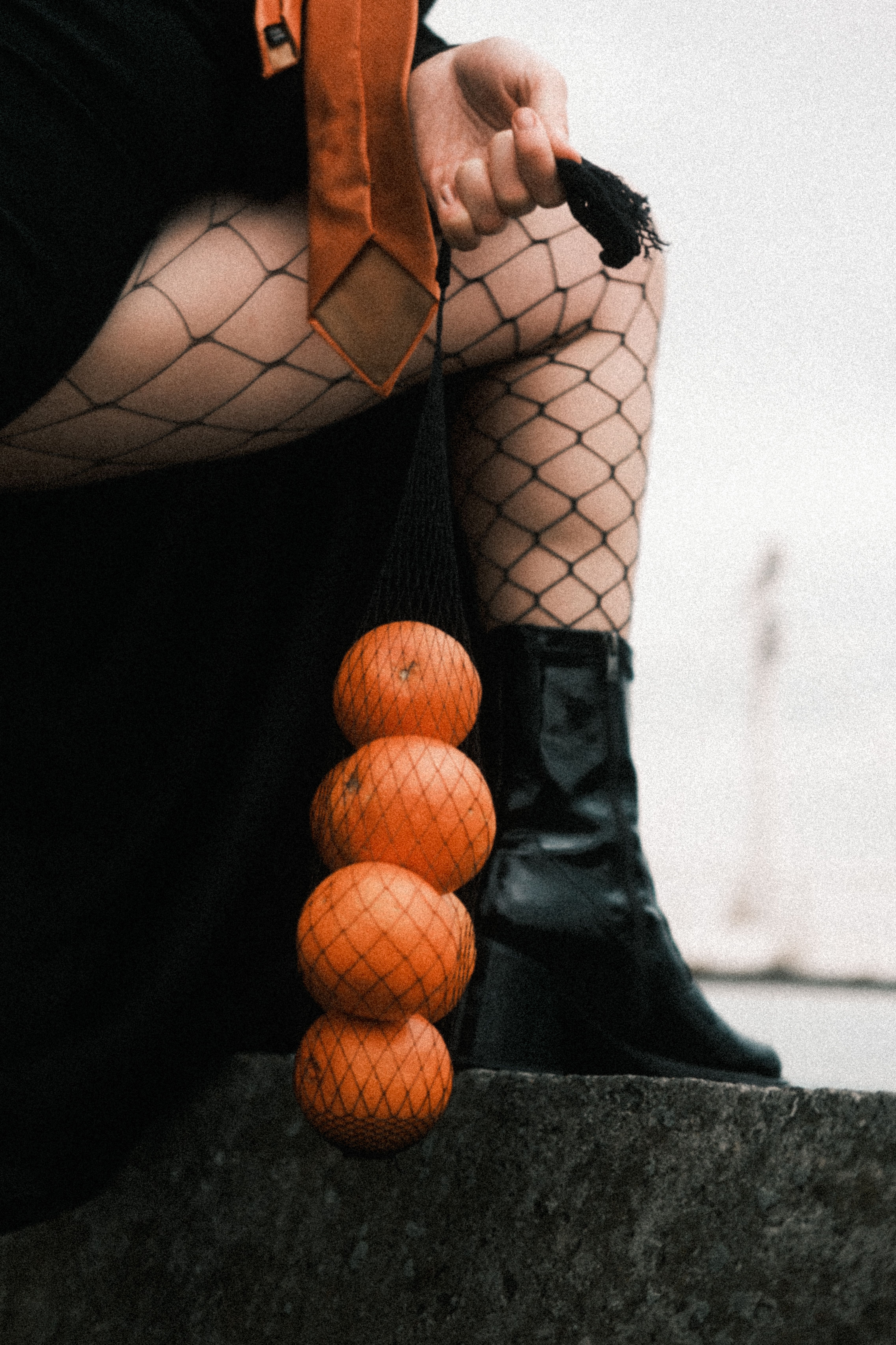 Stylish Urban Scene with Oranges and Fishnet Fashion · Free Stock Photo