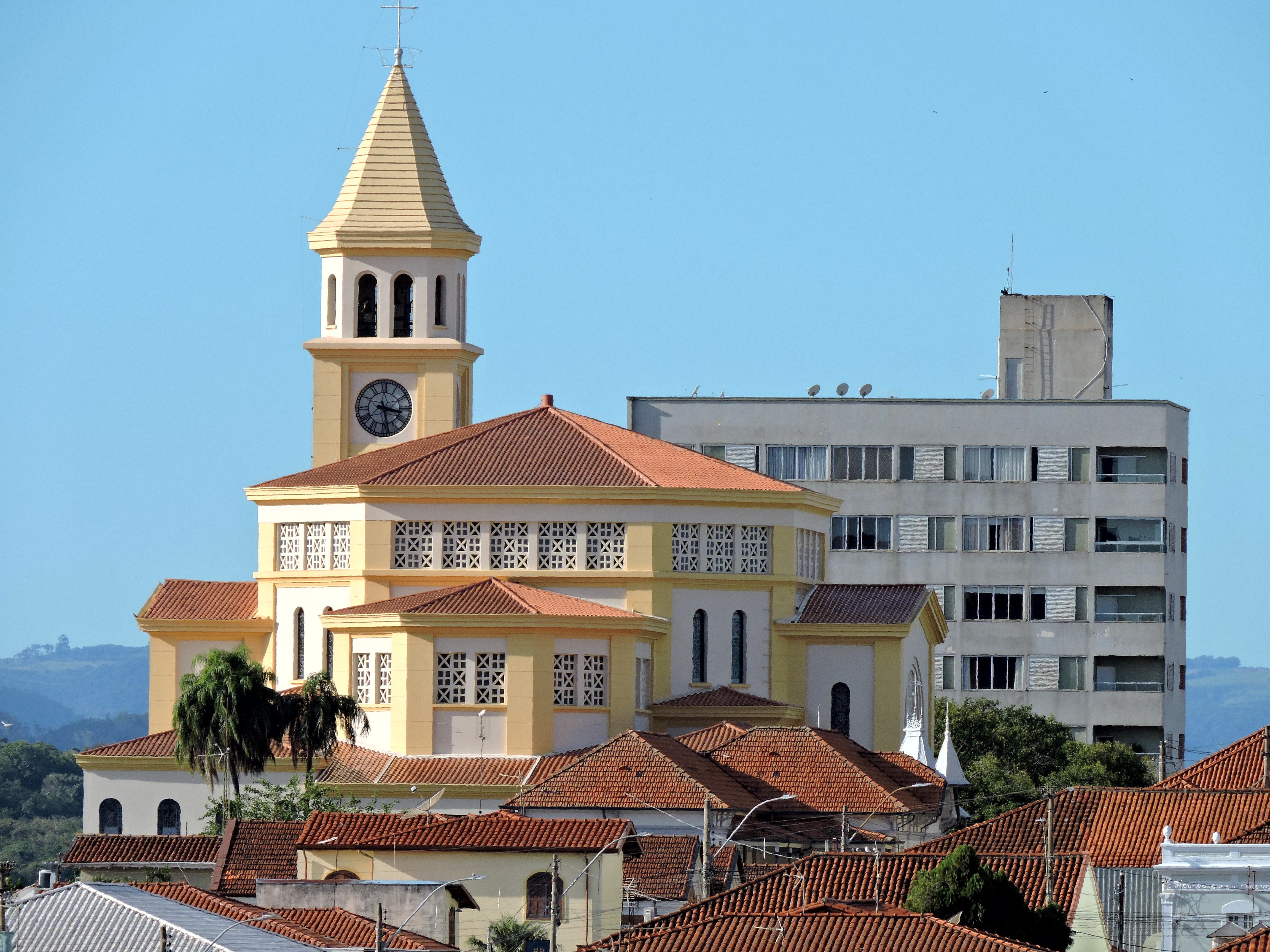 Vibrant Yellow Church with Clock Tower in Cityscape · Free Stock Photo