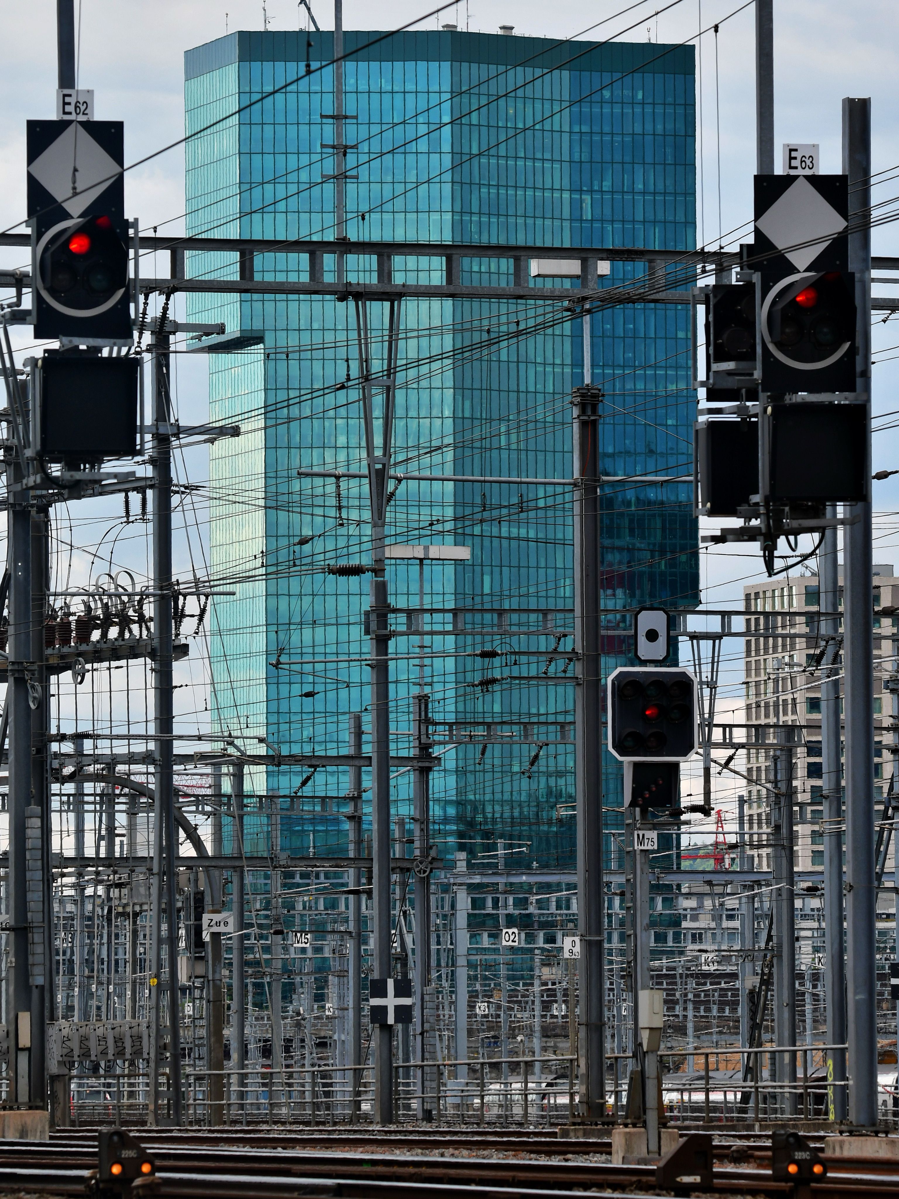 Urban Train Tracks with Green Glass Building · Free Stock Photo