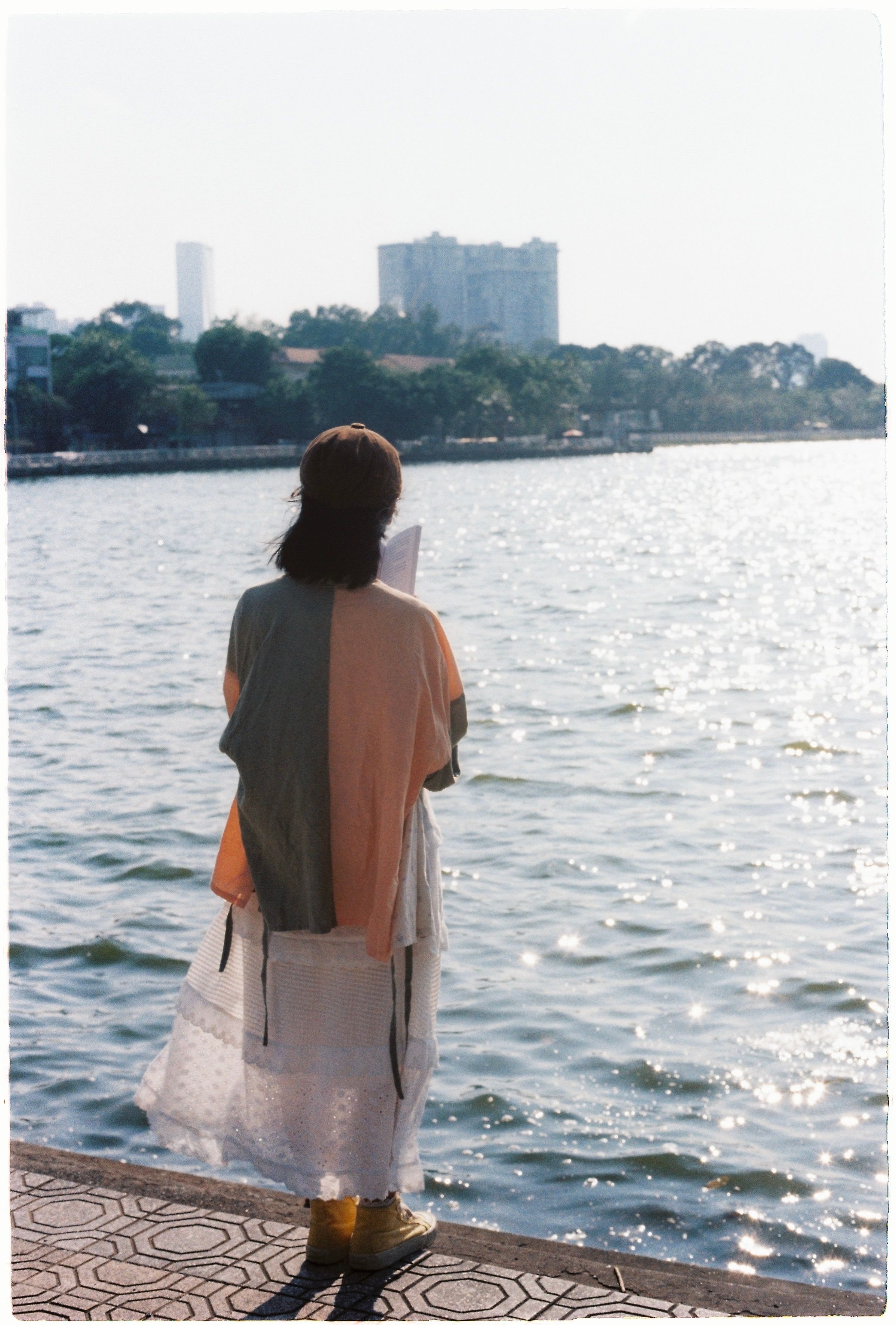 Person Gazing at Water by the Riverside · Free Stock Photo