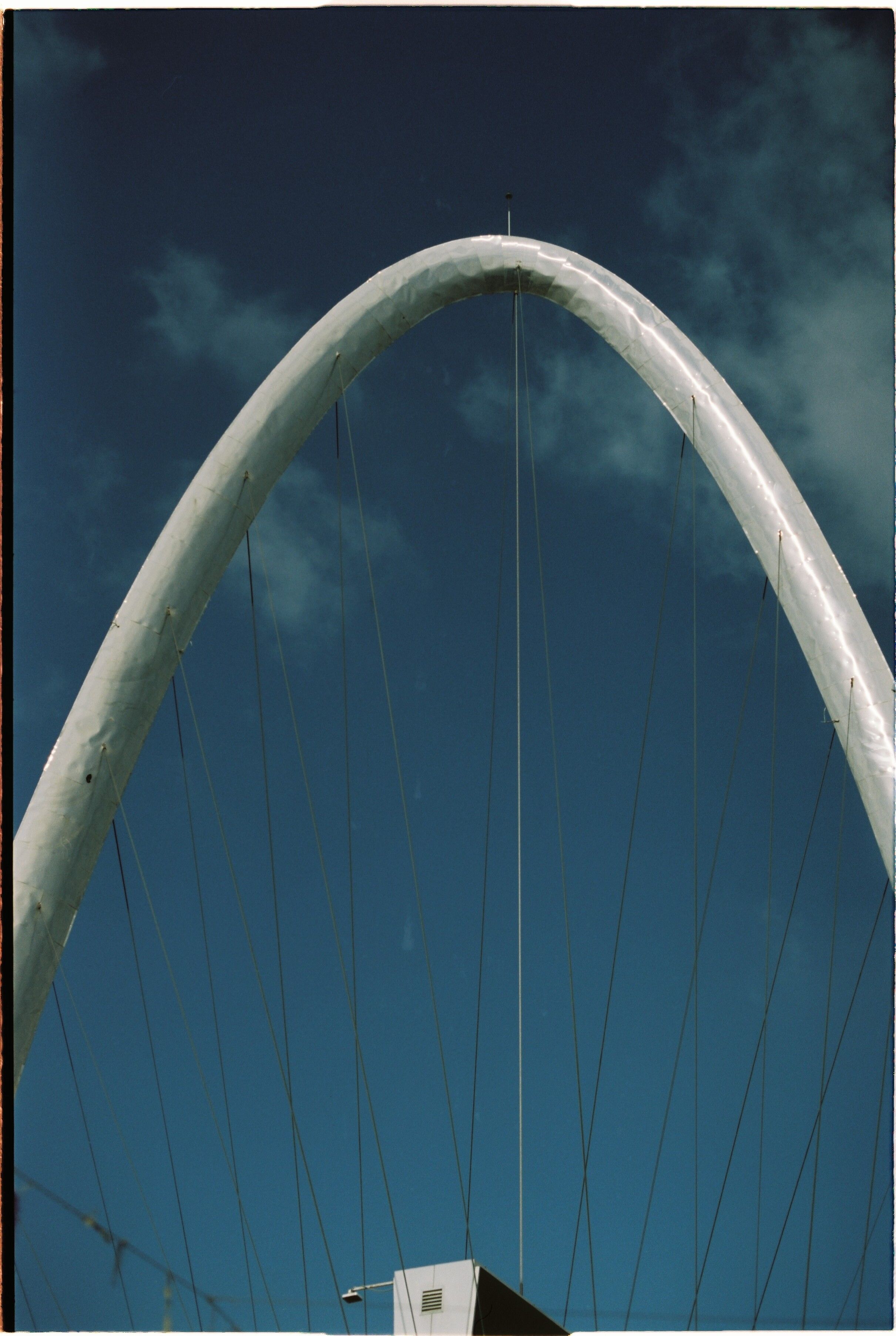 Modern Arch Structure Against a Blue Sky · Free Stock Photo