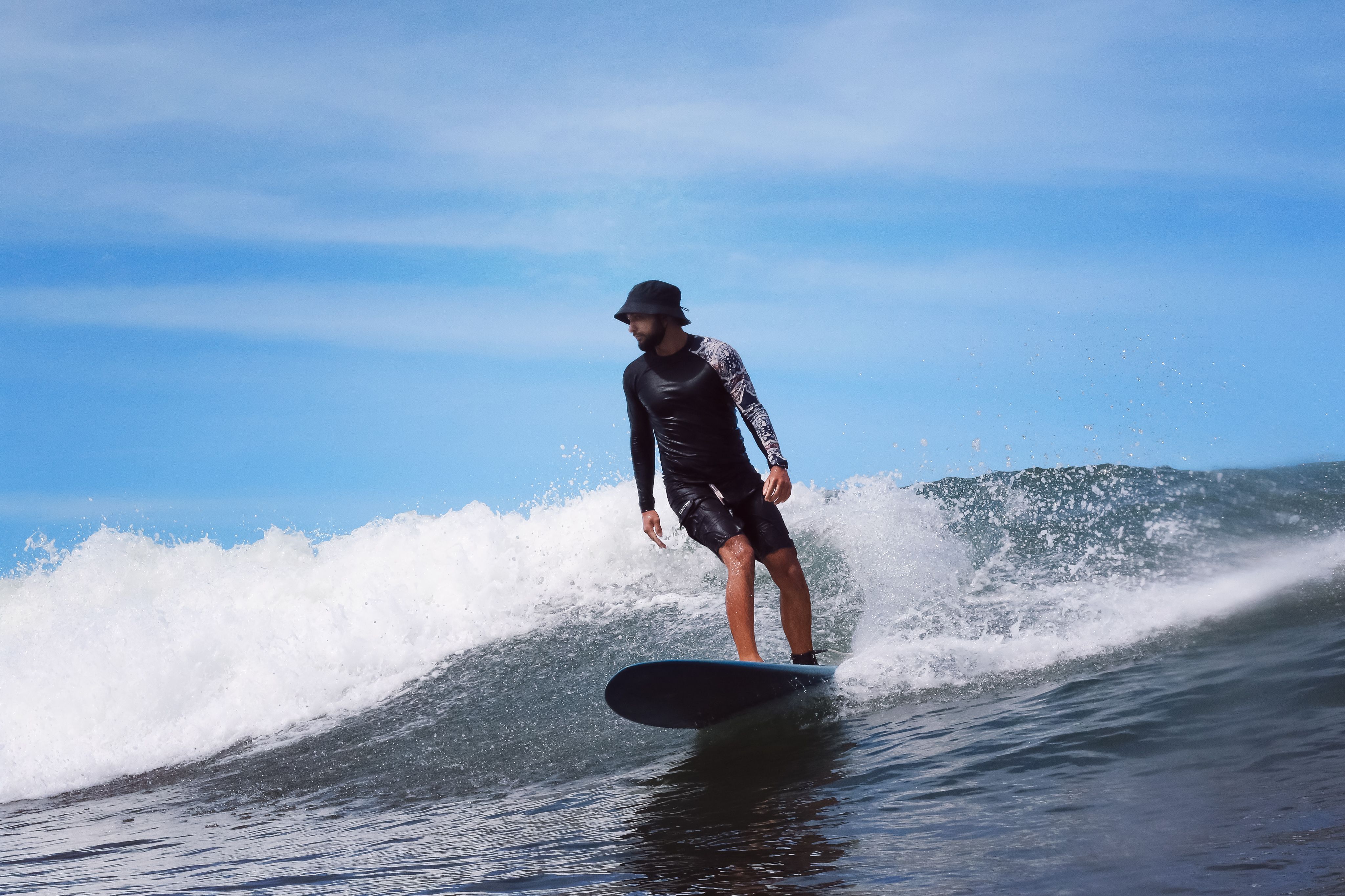 Surfer Riding Ocean Wave on Sunny Day · Free Stock Photo