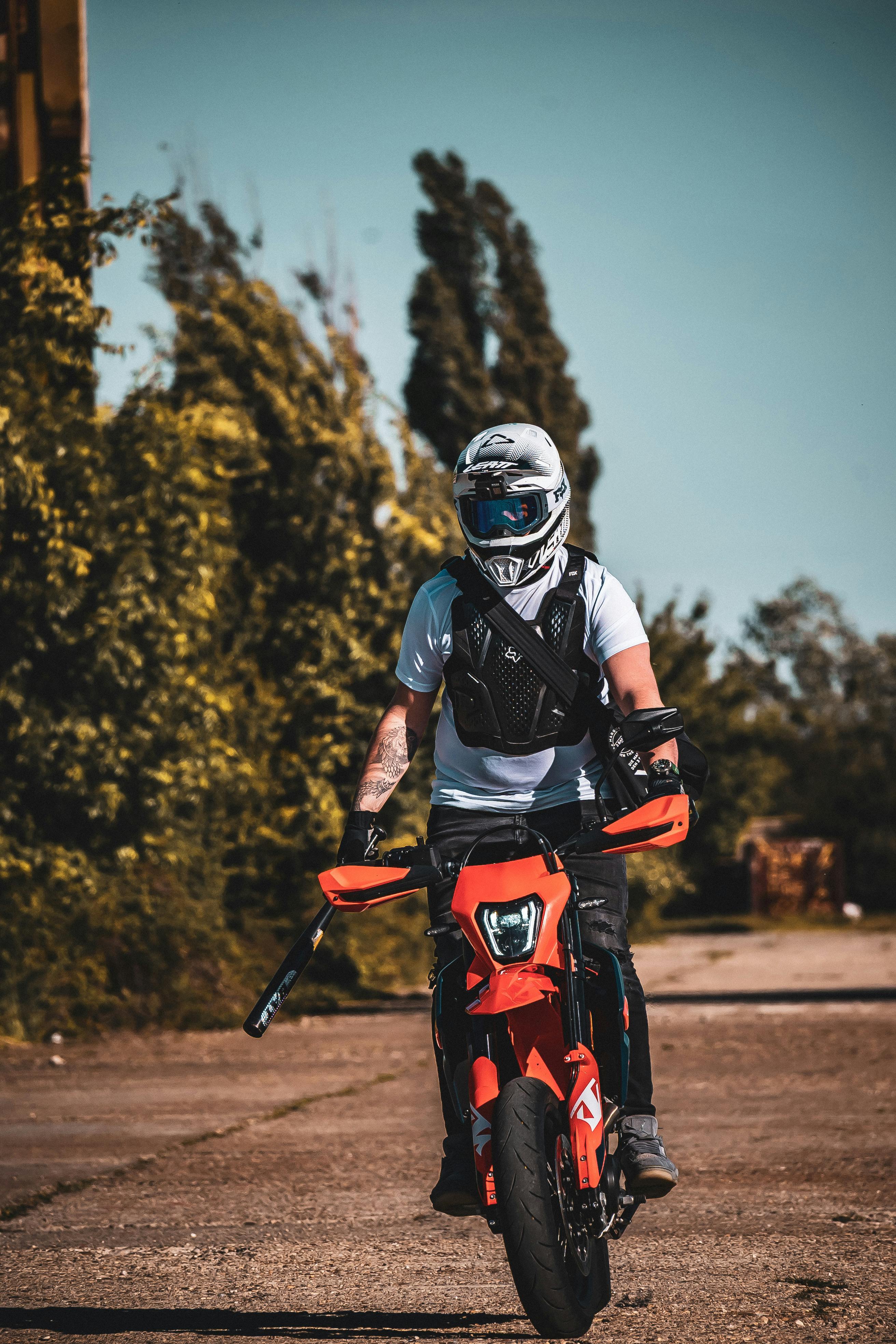 Motorcyclist Riding Red Bike on Sunny Day · Free Stock Photo