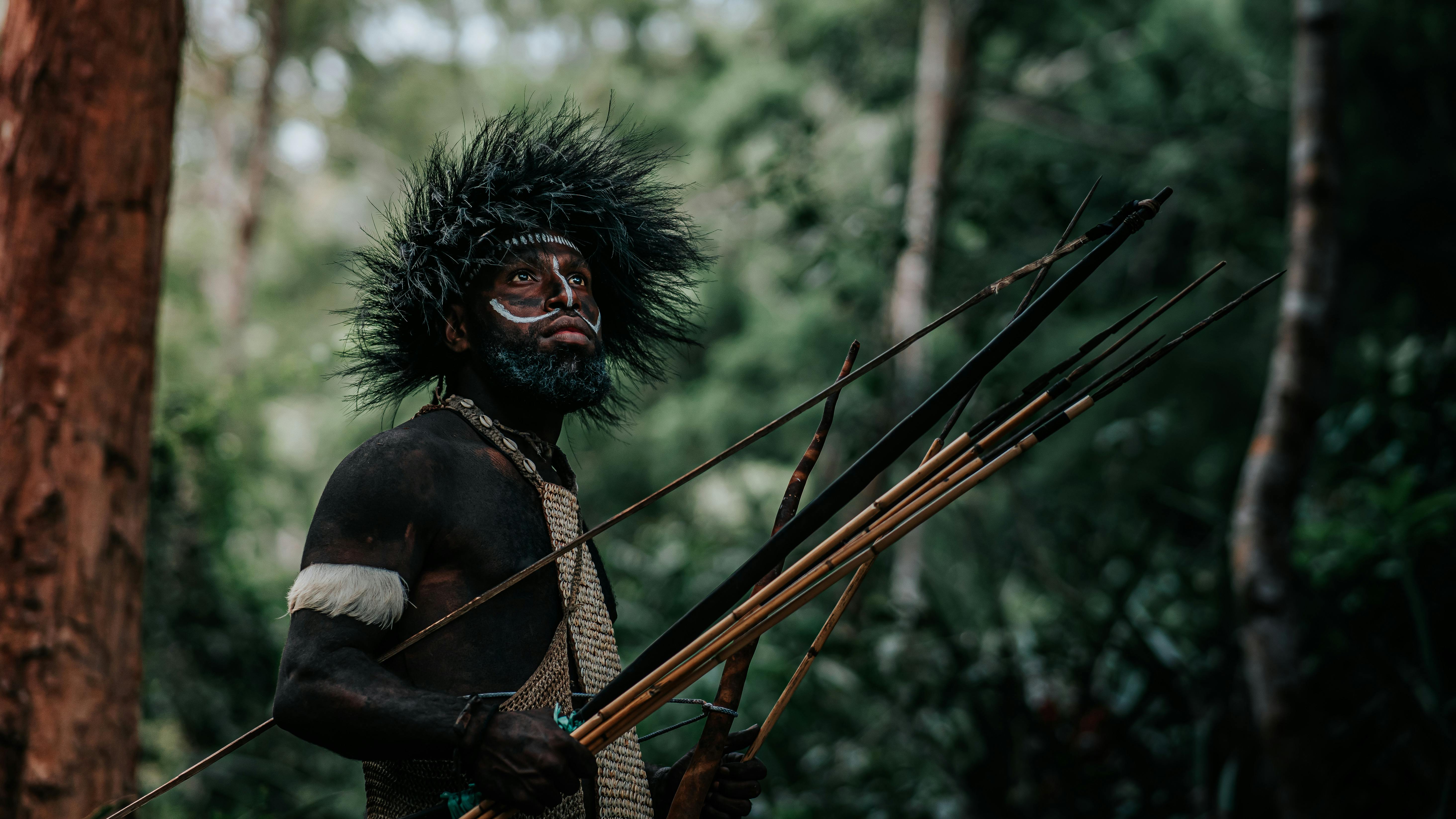 Indigenous Hunter in Traditional Attire with Bow and Arrows · Free ...